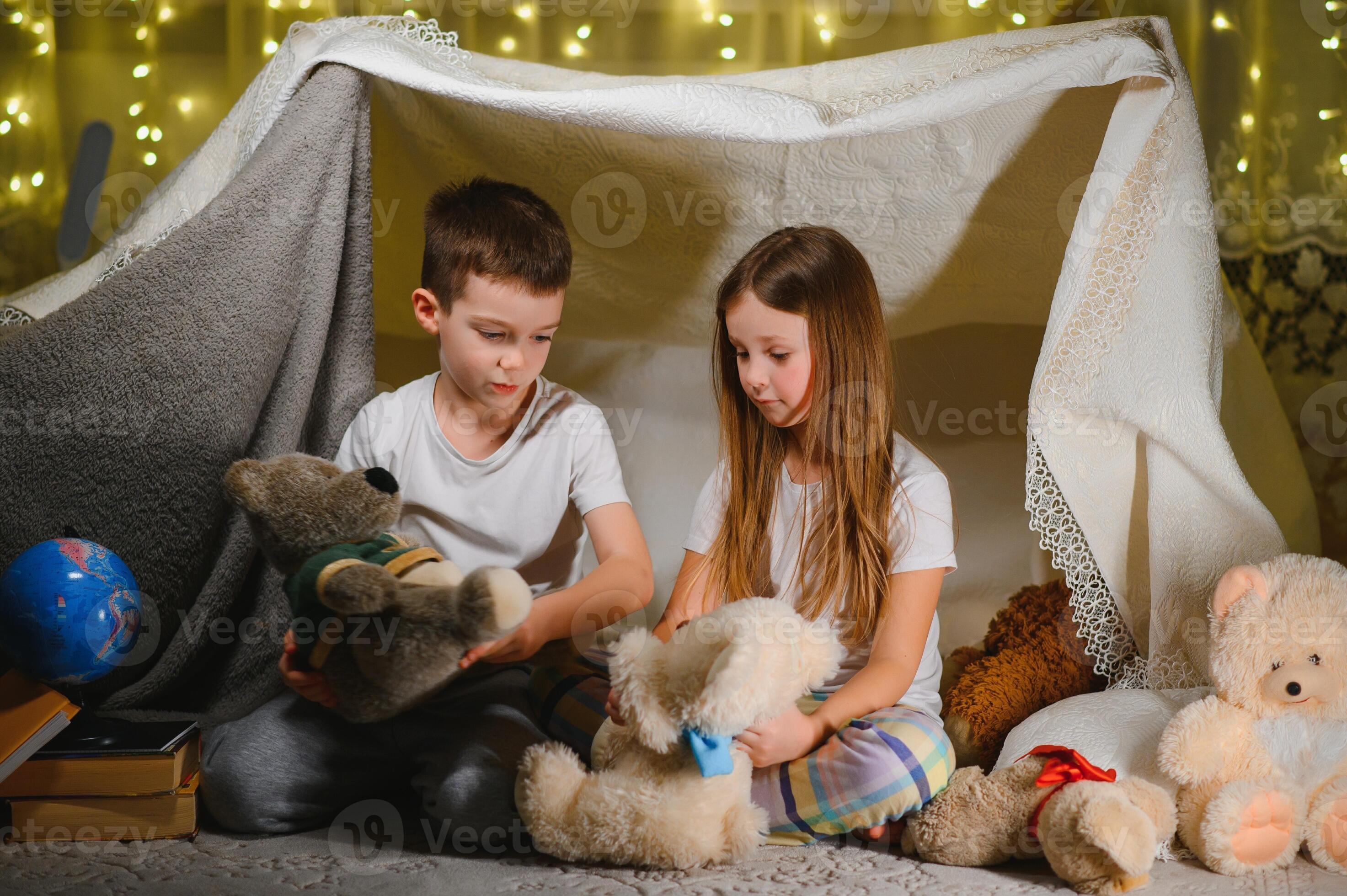 Siblings Sit In A Hut Of Chairs And Blankets Brother And Sister