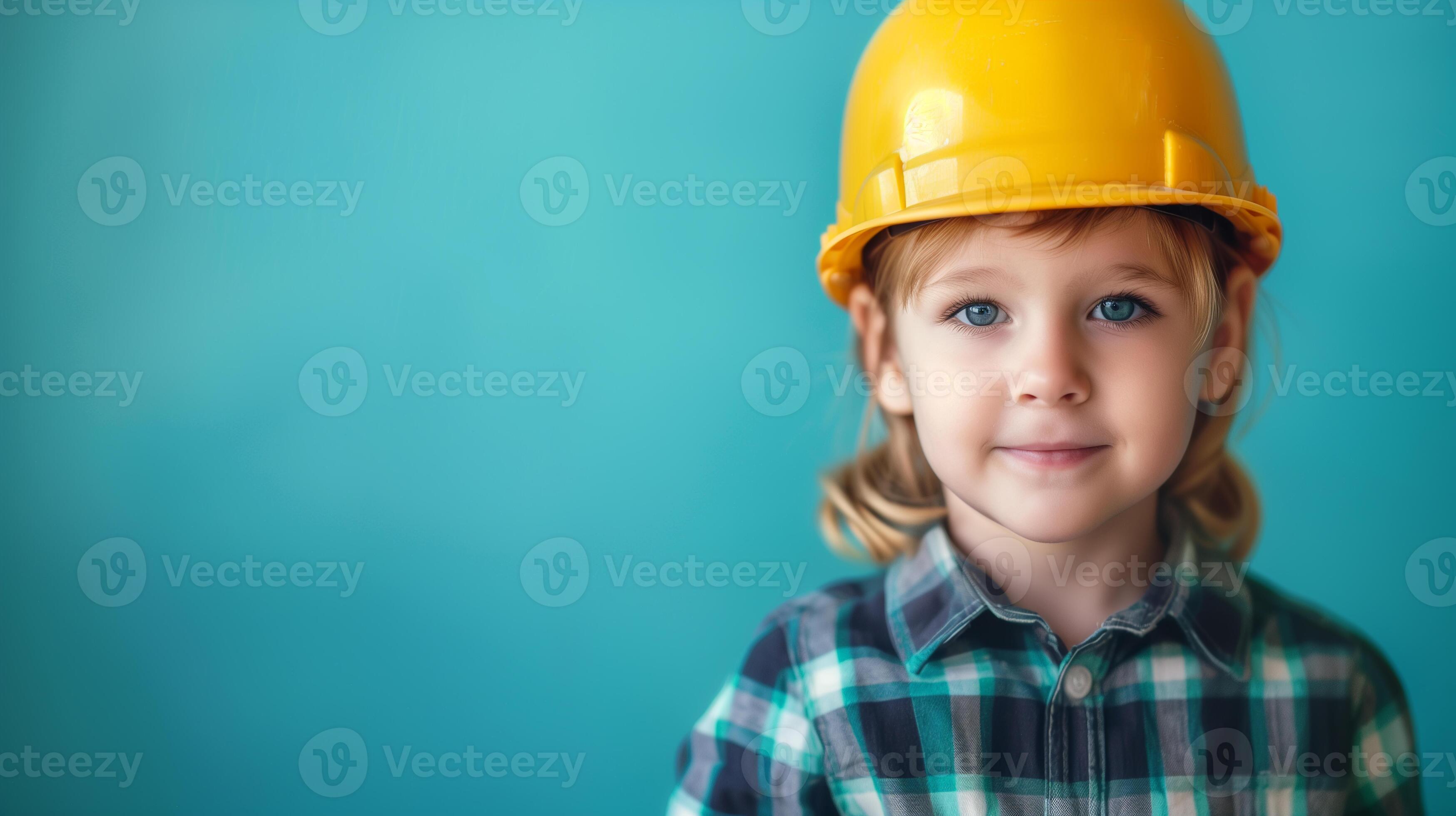 Young Child in Construction Helmet. Portrait of a young child wearing a yellow construction ...