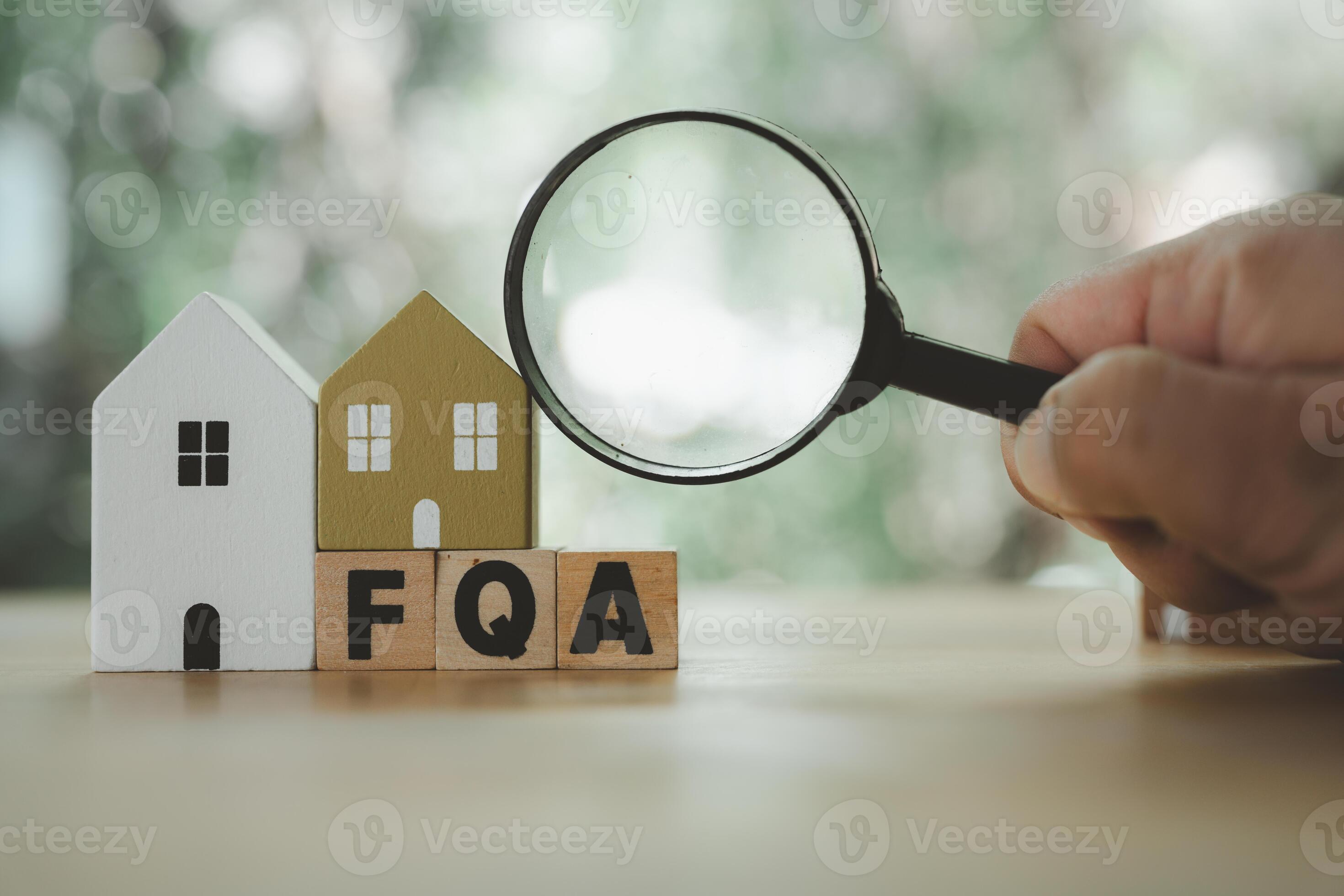 Man hand uses magnifying glass to find answer FAQ about home. Question and answer about housing ...