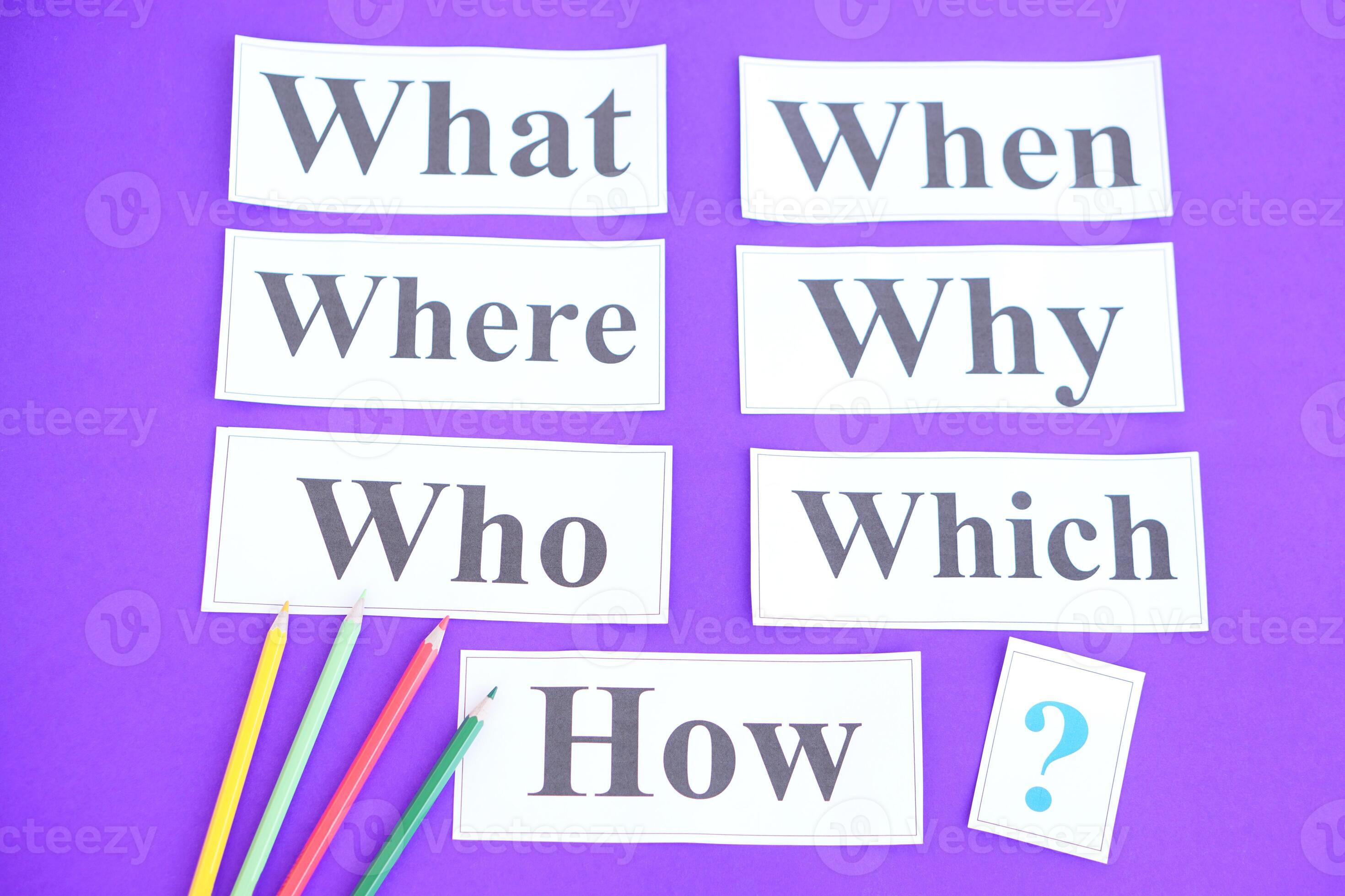 Paper cards with Wh-question words and question marks on purple ...