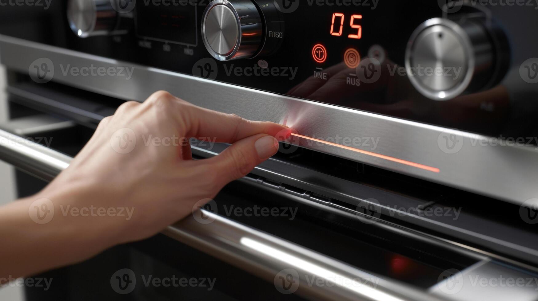 A timer button being pushed on a convection oven with a bright red ...