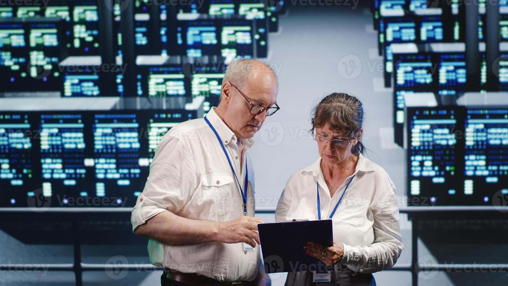 Cloud computing business executives looking around data center, using clipboard to crosscheck ...