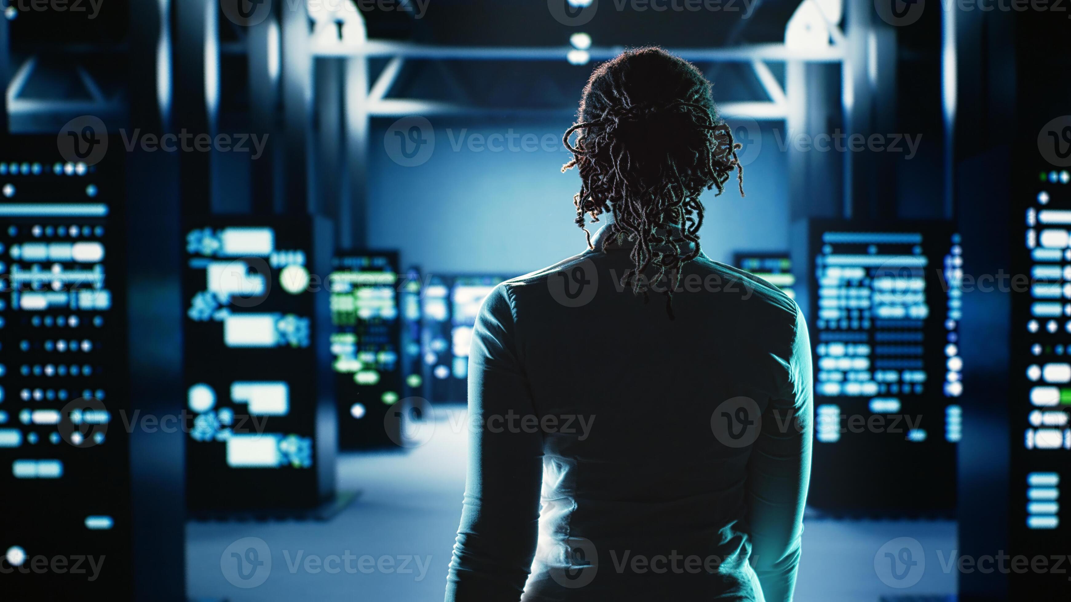 Employee Walking Through Data Center Infrastructure Clusters Providing Processing Resources For