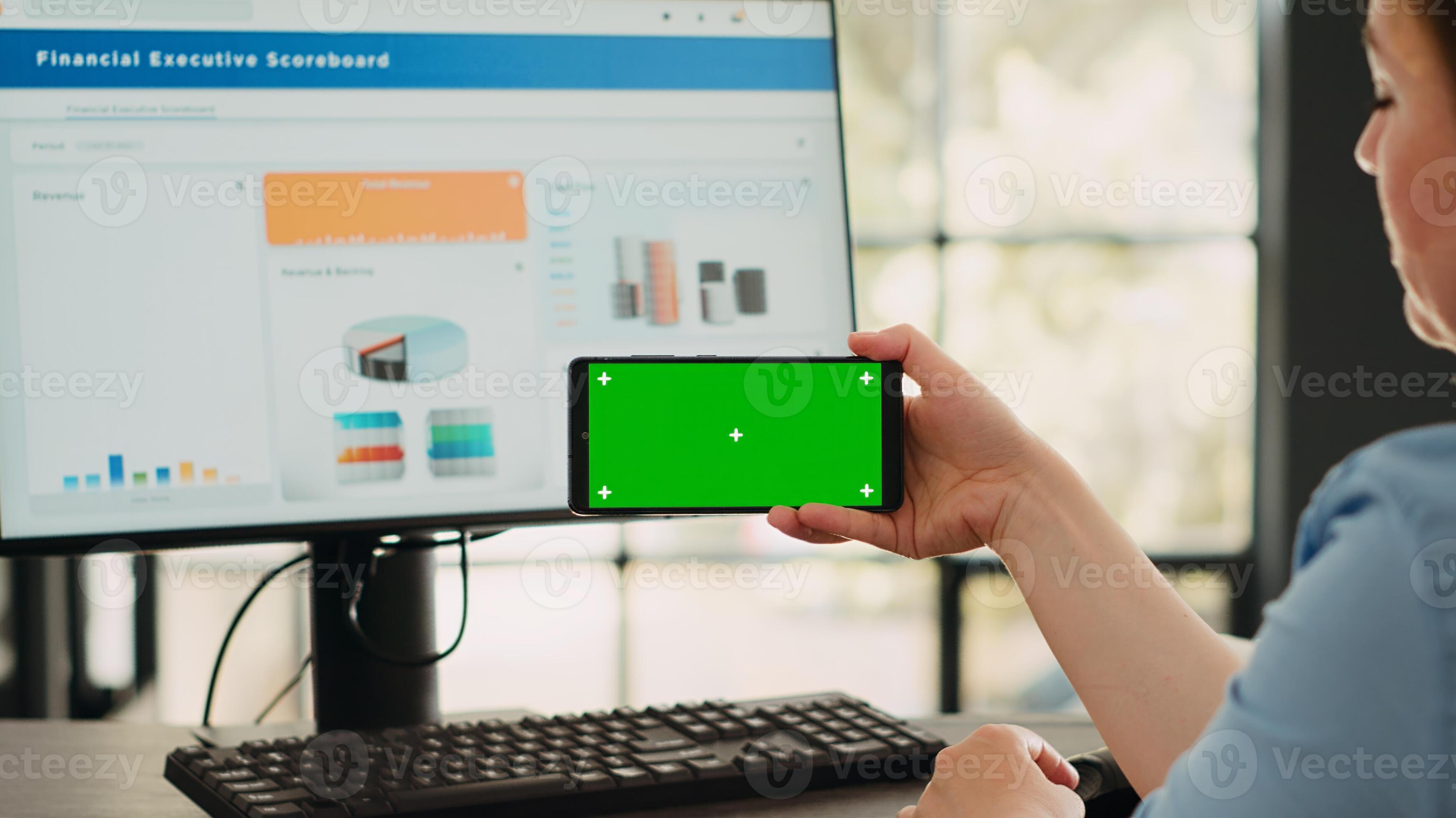 Businesswoman Analyzing Smartphone App With Greenscreen Template In