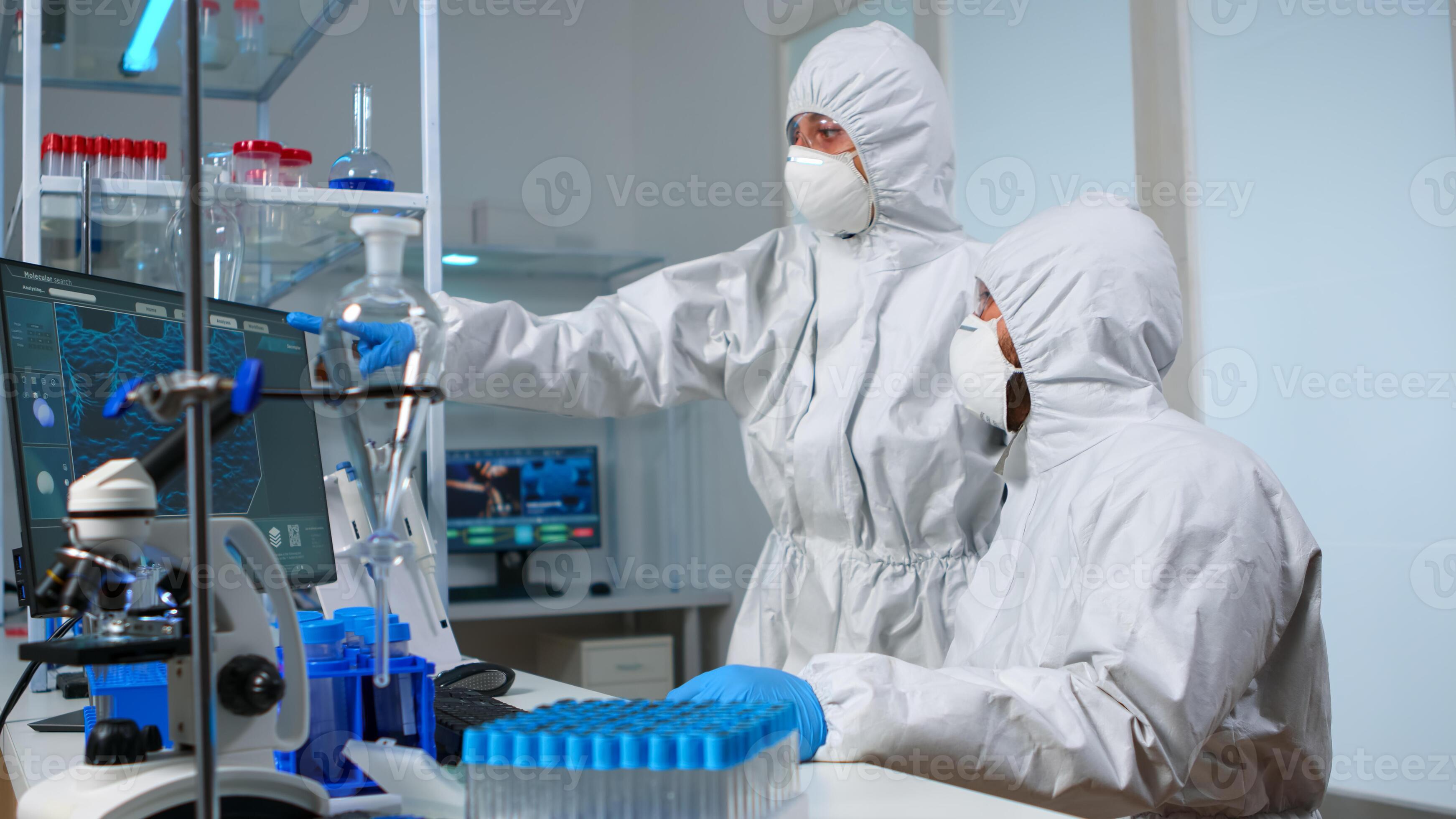 Scientist Team In Prorection Suit Arguing In Front Of Pc Looking At