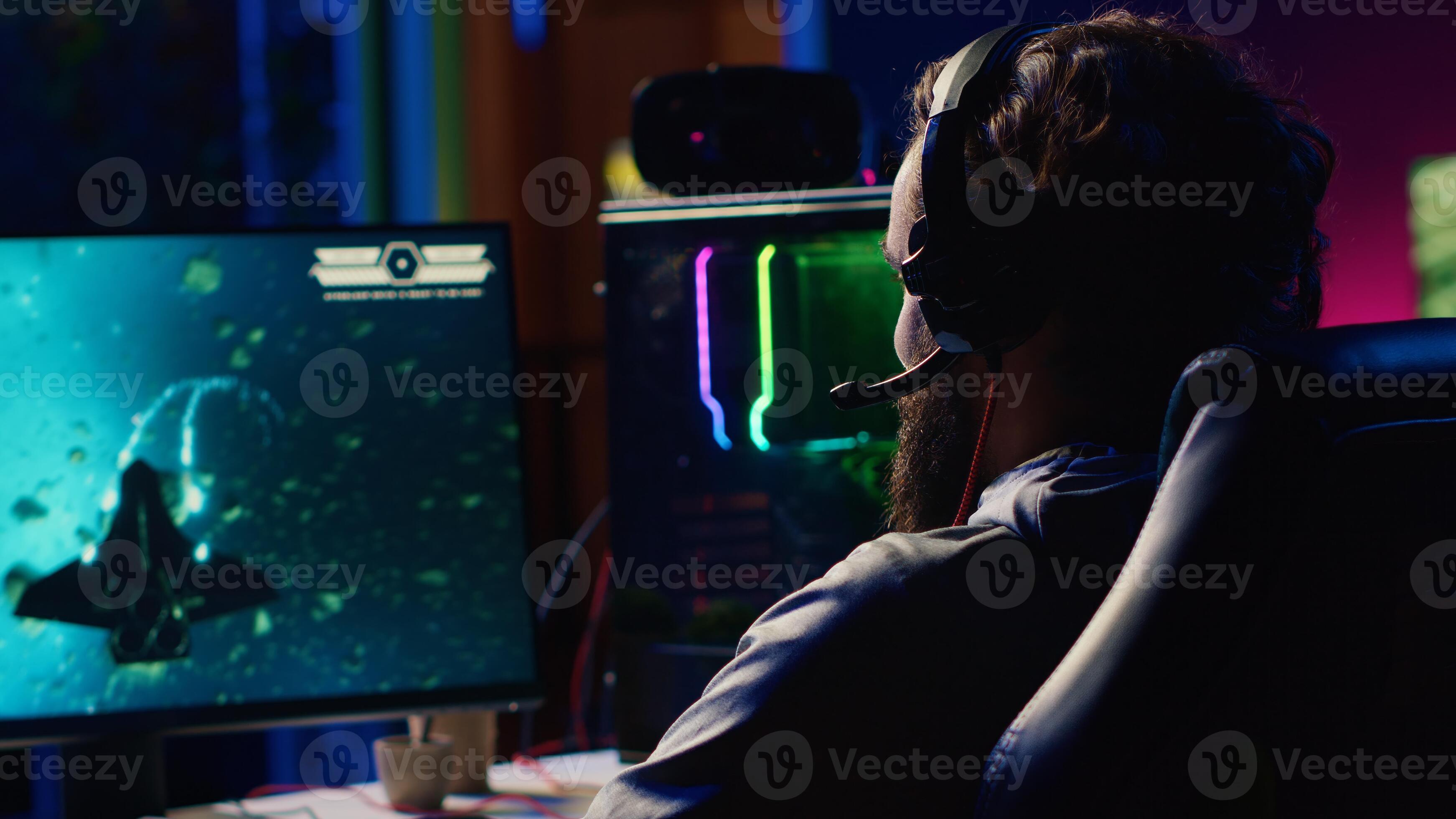 Man playing high FPS singleplayer game with spaceship shooting laser streams at asteroid. Gamer ...