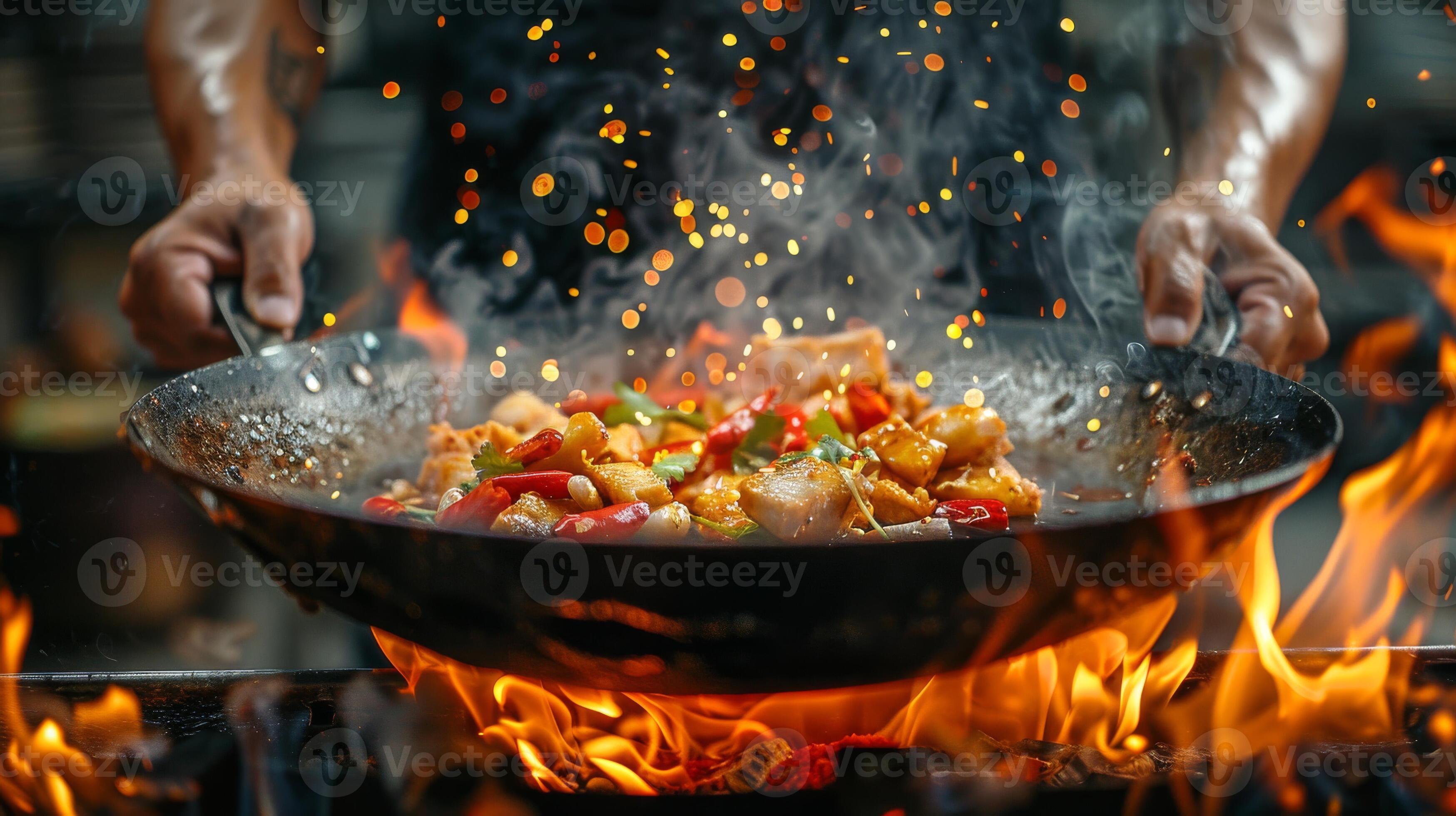Intense flames engulf Thai dish as chef cooks in a wok, close-up on cooking seafood and ...