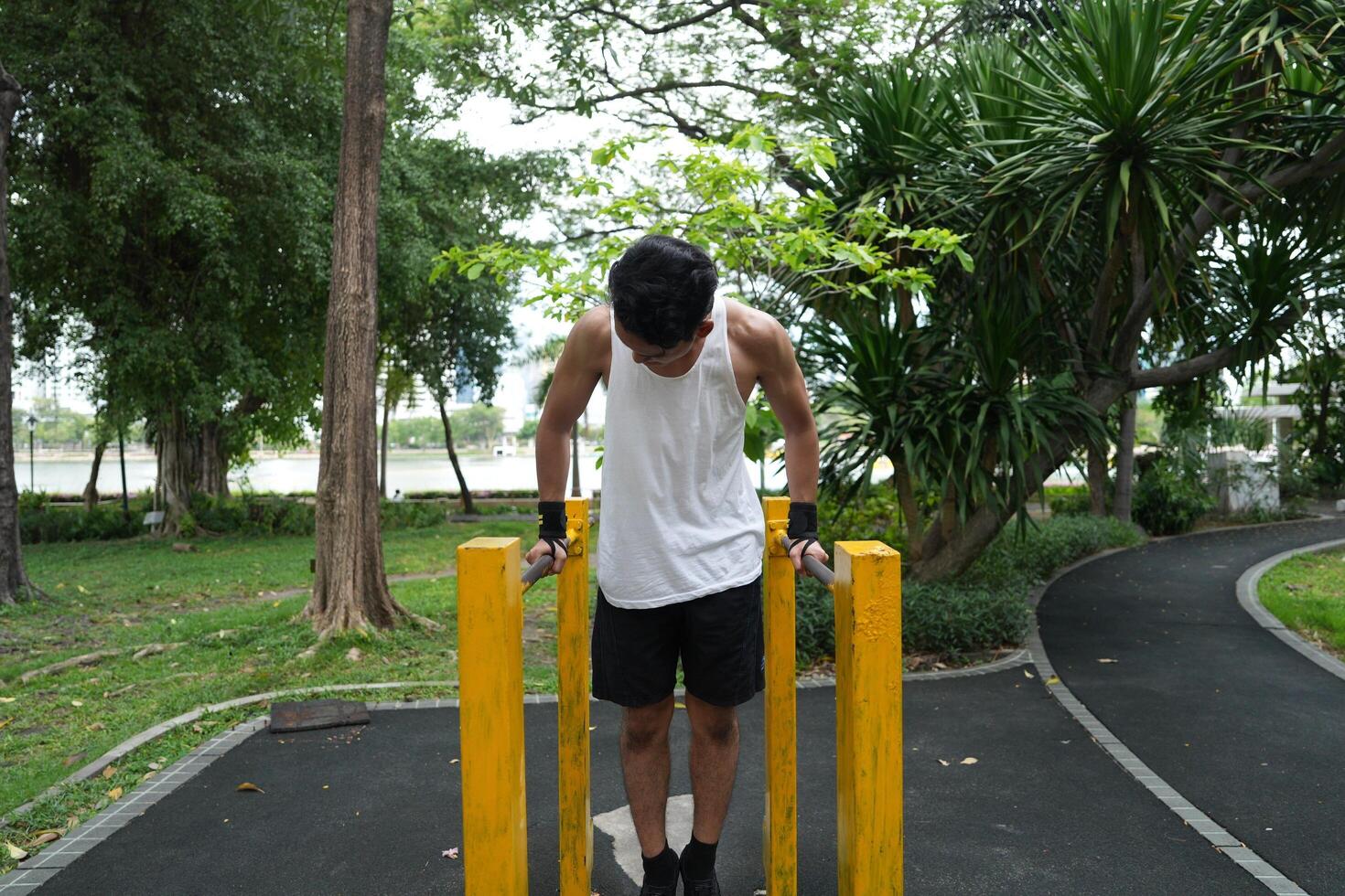 Asian Man Practicing Gymnastics Doing Gymnastics Bar And Hoop Exercises And Stretching Resting