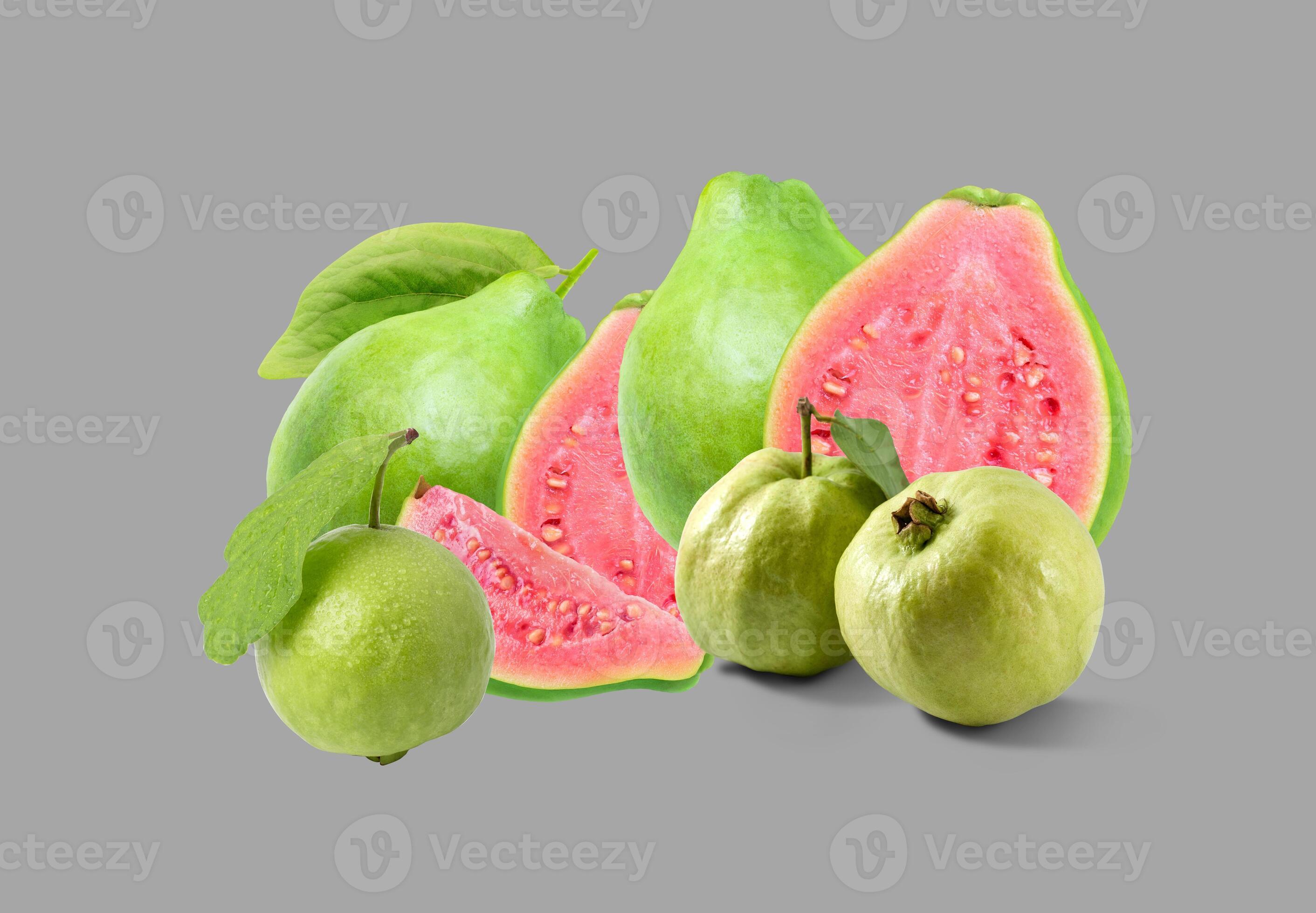 Whole and sliced guavas with vibrant pink interiors, rich in flavor and ... Whole and sliced guavas with vibrant pink interiors, rich in flavor and ...