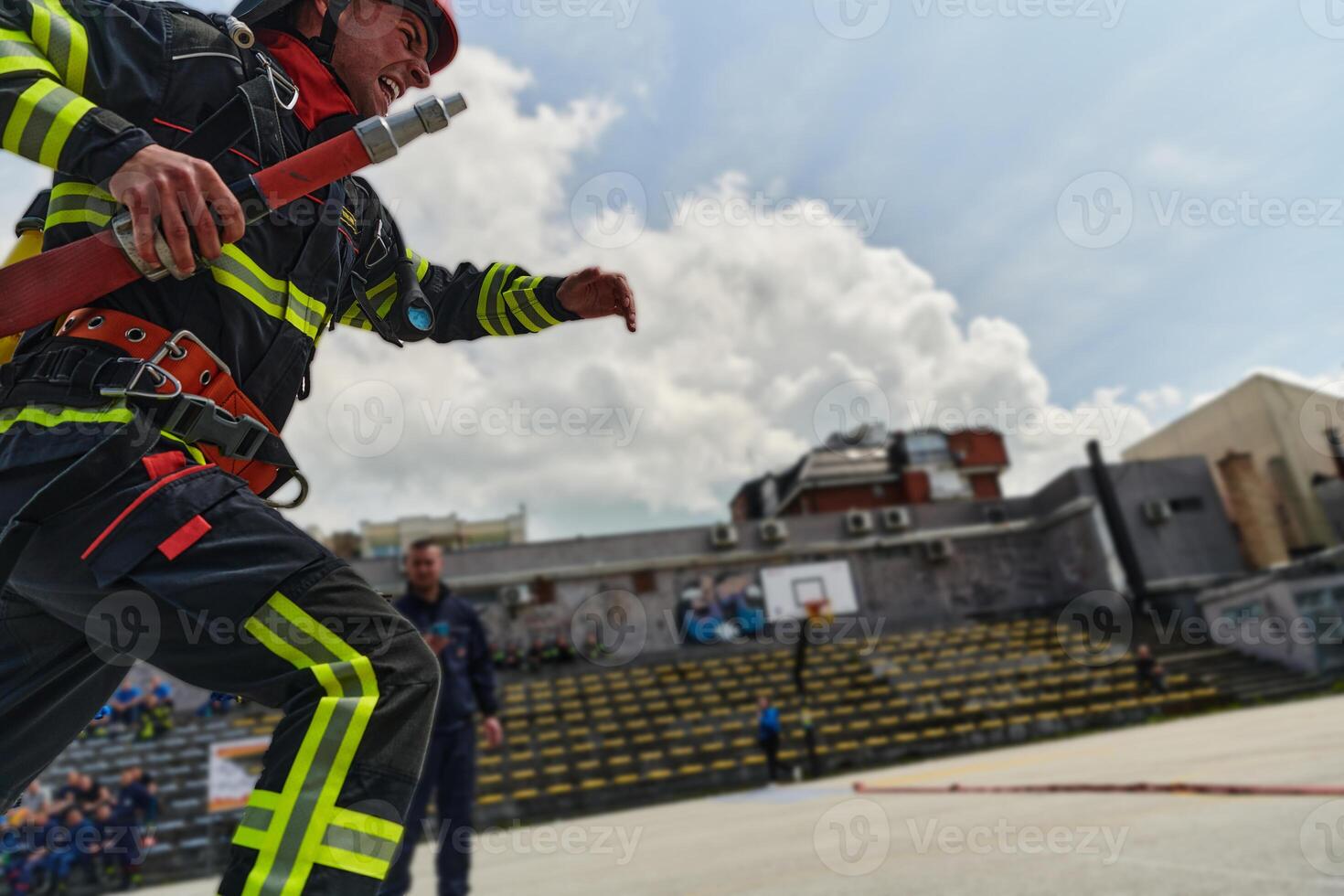 In a dynamic display of synchronized teamwork, firefighters hustle to ... In a dynamic display of synchronized teamwork, firefighters hustle to ...