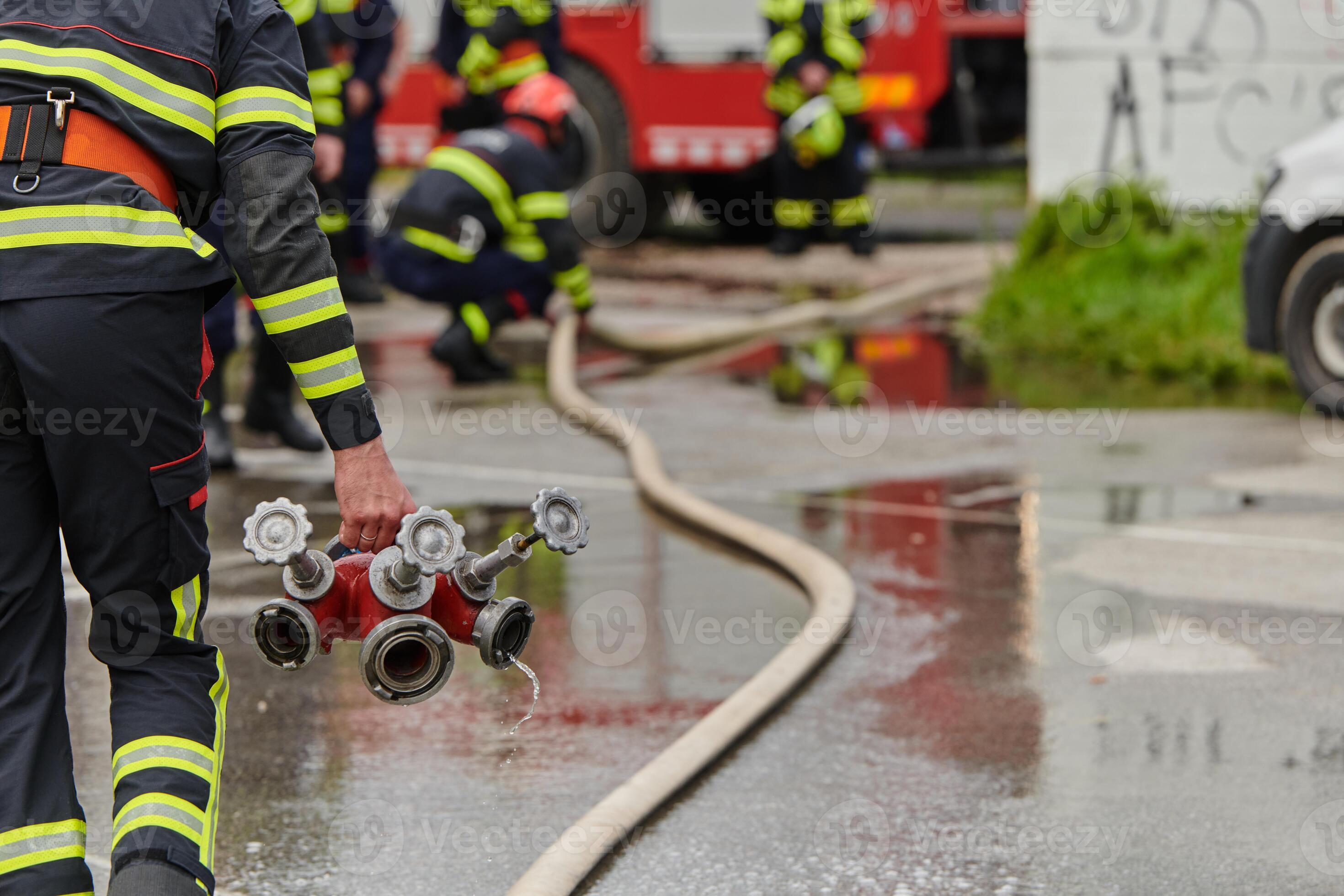In a dynamic display of synchronized teamwork, firefighters hustle to ... In a dynamic display of synchronized teamwork, firefighters hustle to ...