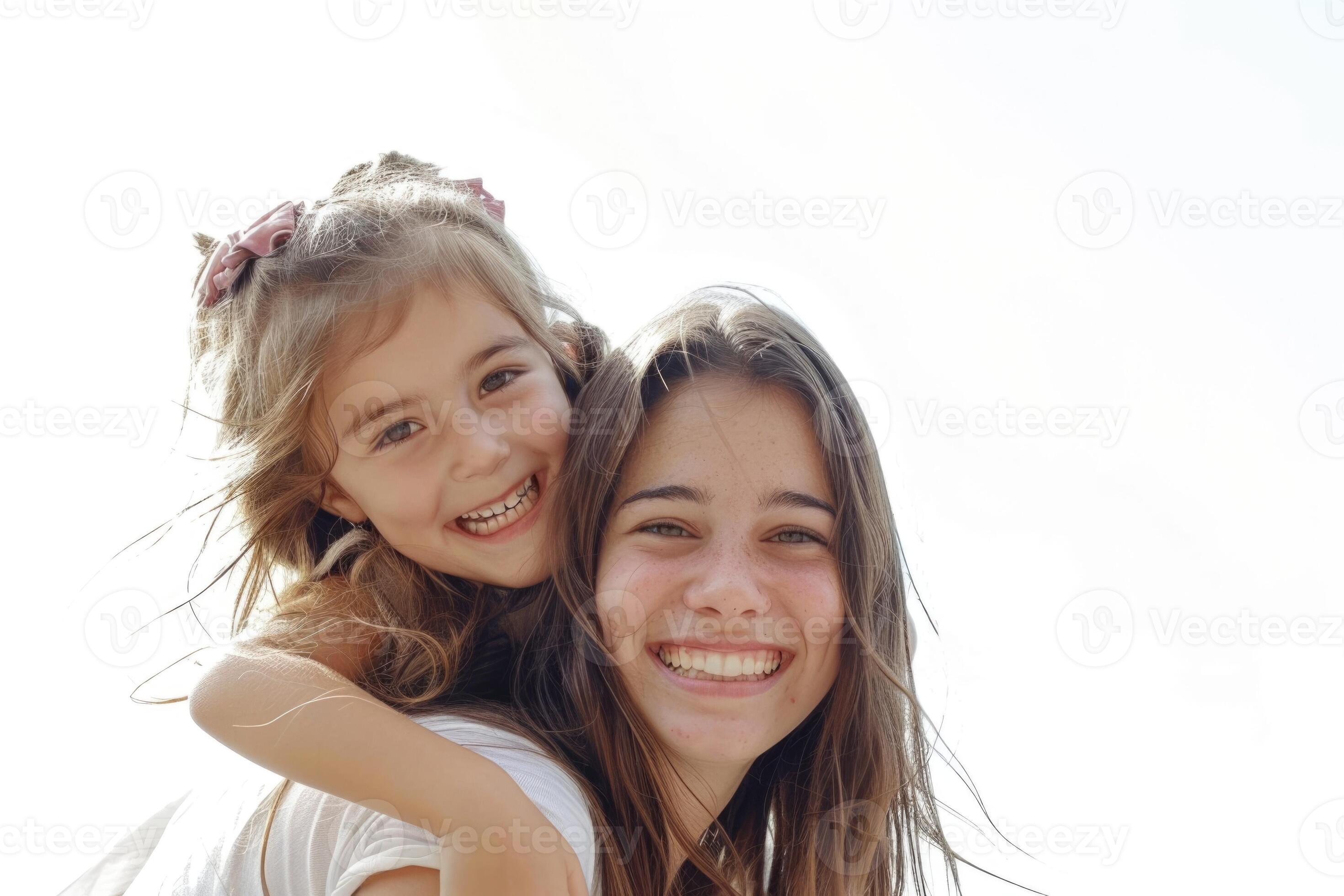 Cheerful mother giving piggyback ride to her daughter against a white ... Cheerful mother giving piggyback ride to her daughter against a white ...
