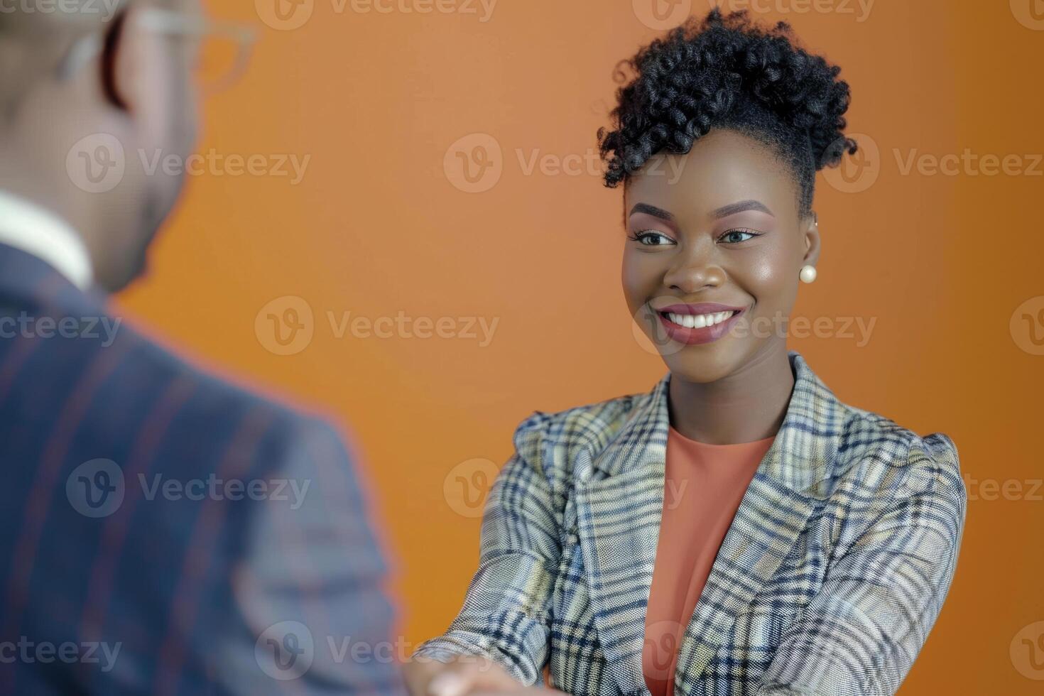 Smiling young black business woman shaking hands with a white business ... Smiling young black business woman shaking hands with a white business ...