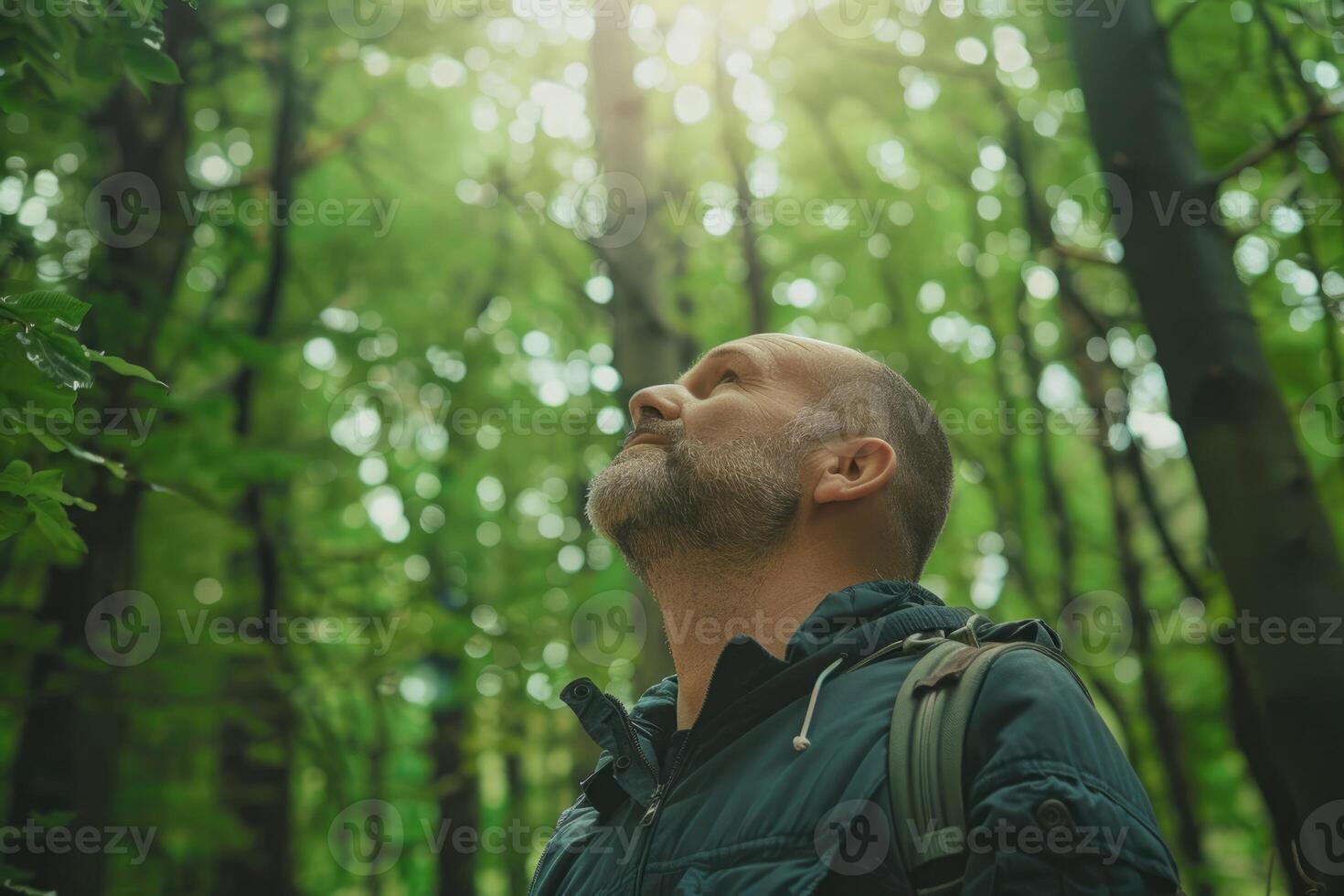 Relaxed adult man breathing fresh air in a forest with green trees in the background 46181872 ...