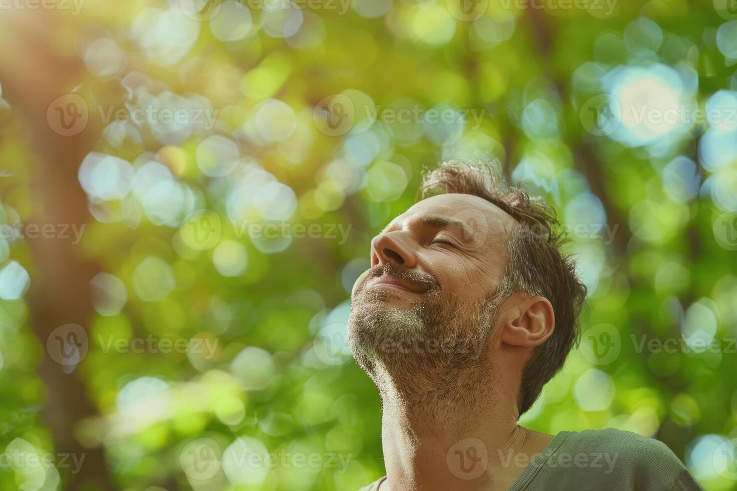 Relaxed adult man breathing fresh air in a forest with green trees in the background 46181883 ...