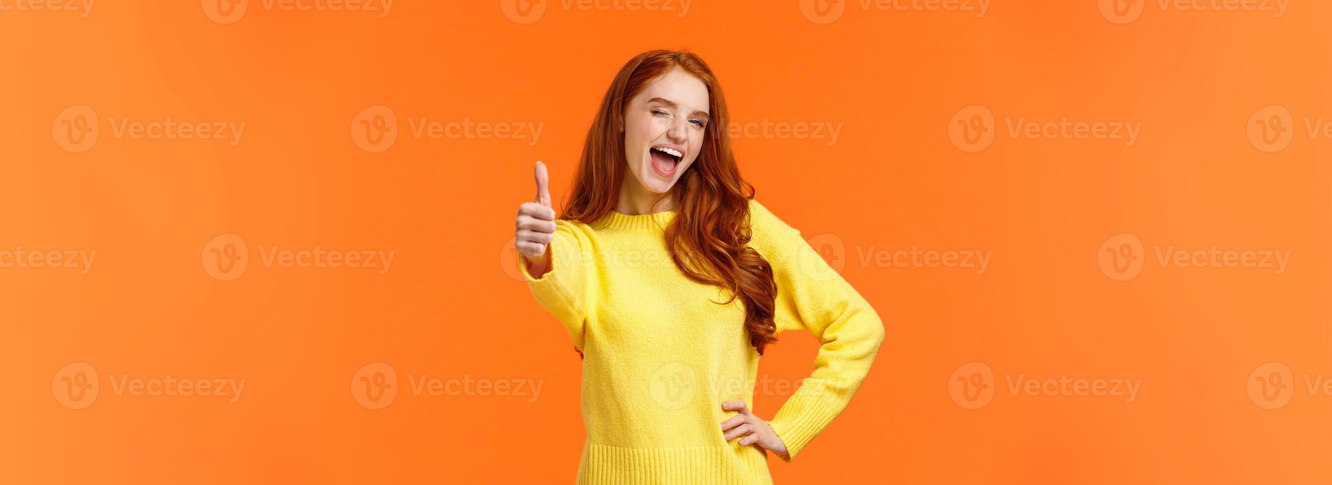 Saying Yes Cheerful Redhead Woman In Yellow Sweater Giving Thumb Up