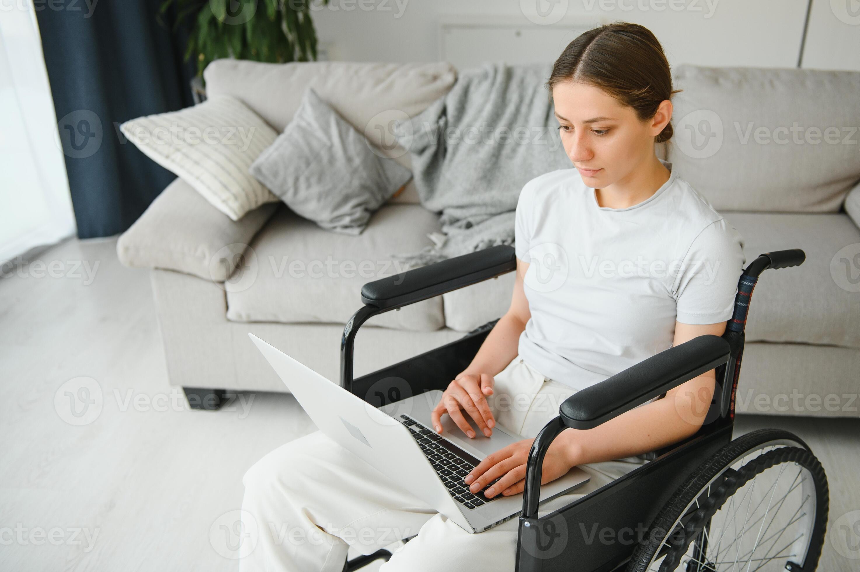 Female Freelance Programmer Sitting In Wheelchair And Using Computers While Coding Web Game At