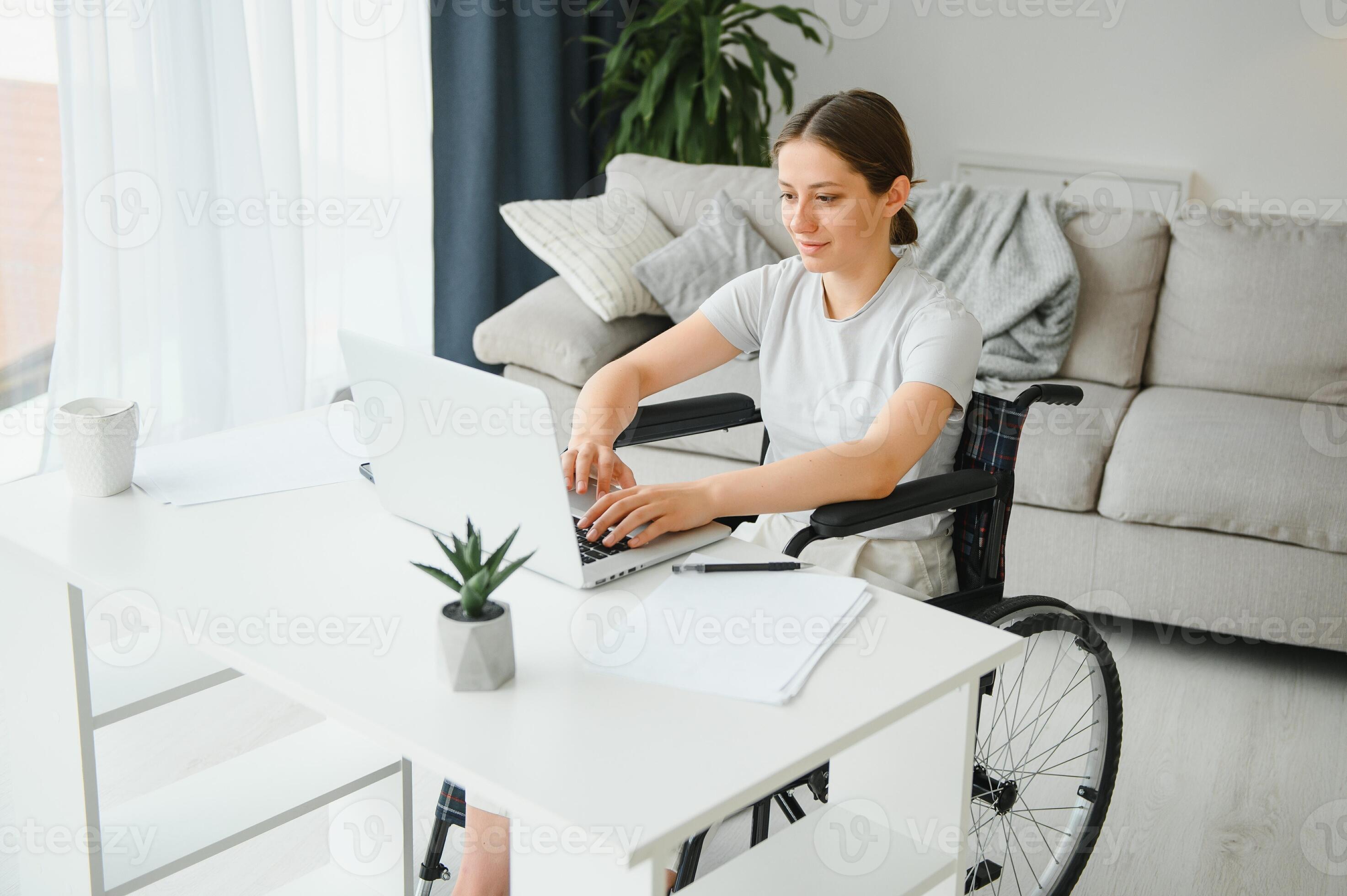 Female Freelance Programmer Sitting In Wheelchair And Using Computers While Coding Web Game At
