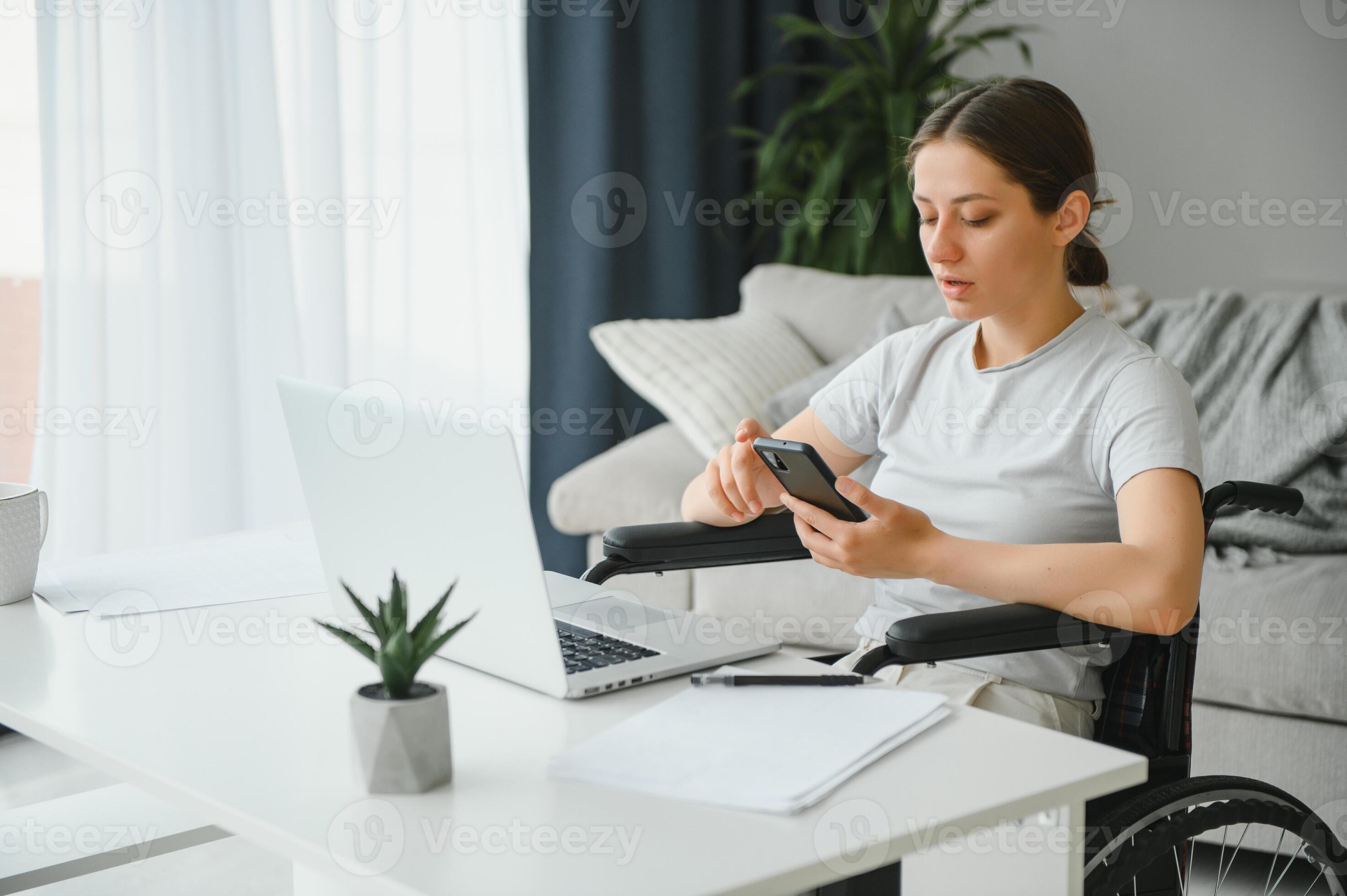 Female Freelance Programmer Sitting In Wheelchair And Using Computers While Coding Web Game At