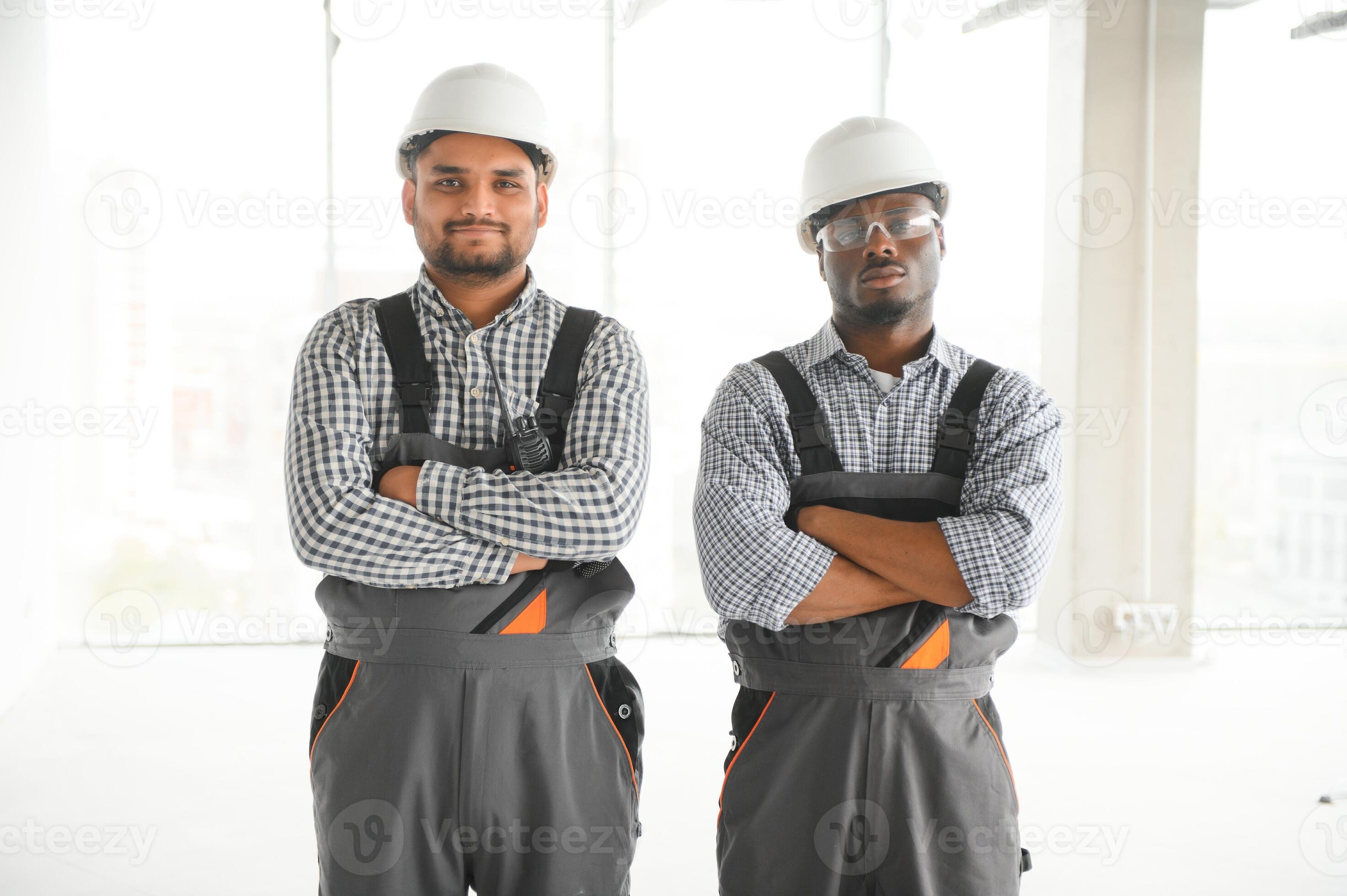 multicultural builders in hardhats at construction site 46388092 Stock Photo at Vecteezy