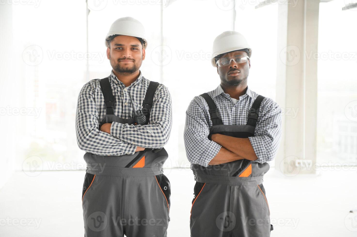 multicultural builders in hardhats at construction site 46388092 Stock Photo at Vecteezy