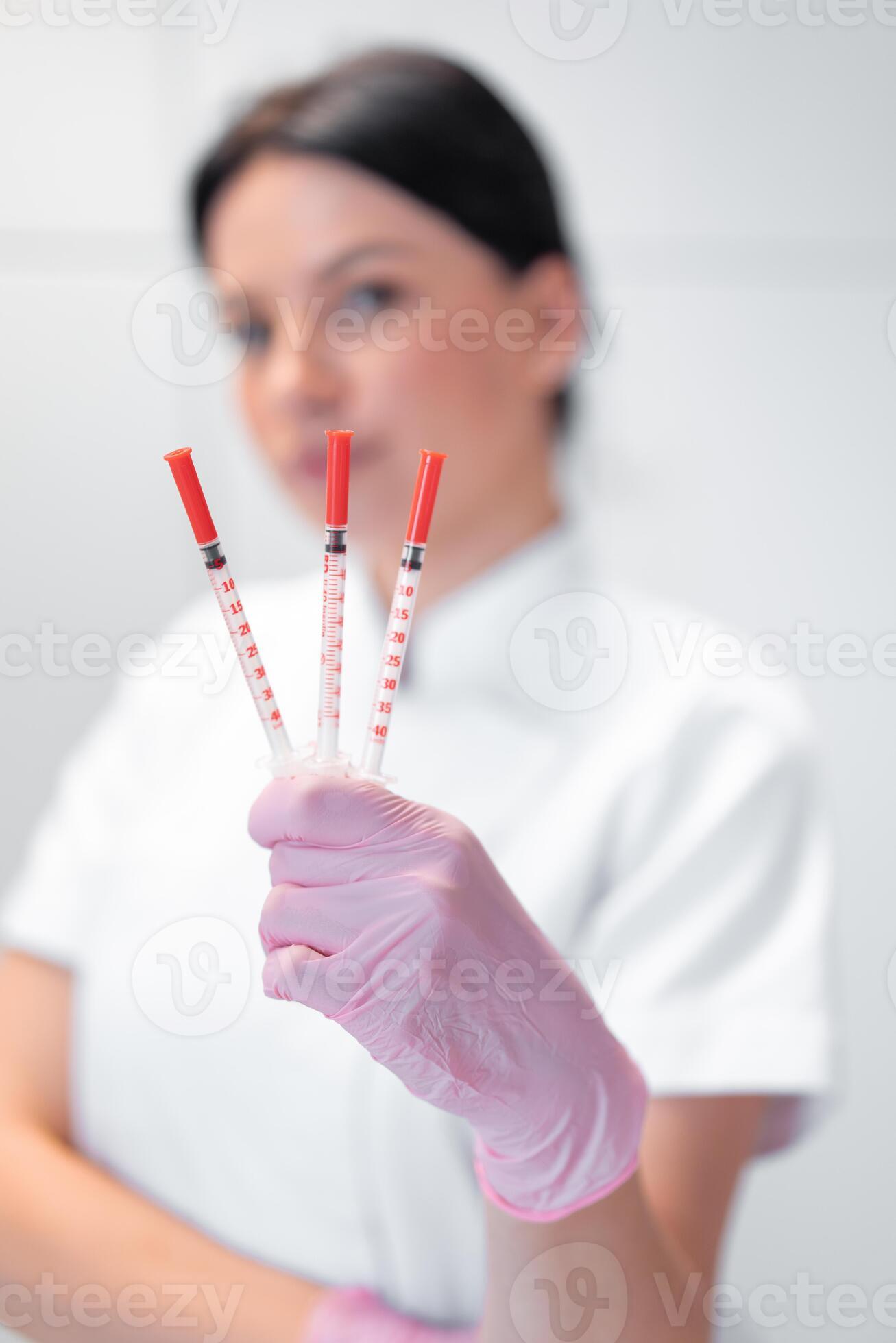 Cosmetologist woman showing three syringes in clinic 46405352 Stock ... Cosmetologist woman showing three syringes in clinic 46405352 Stock ...