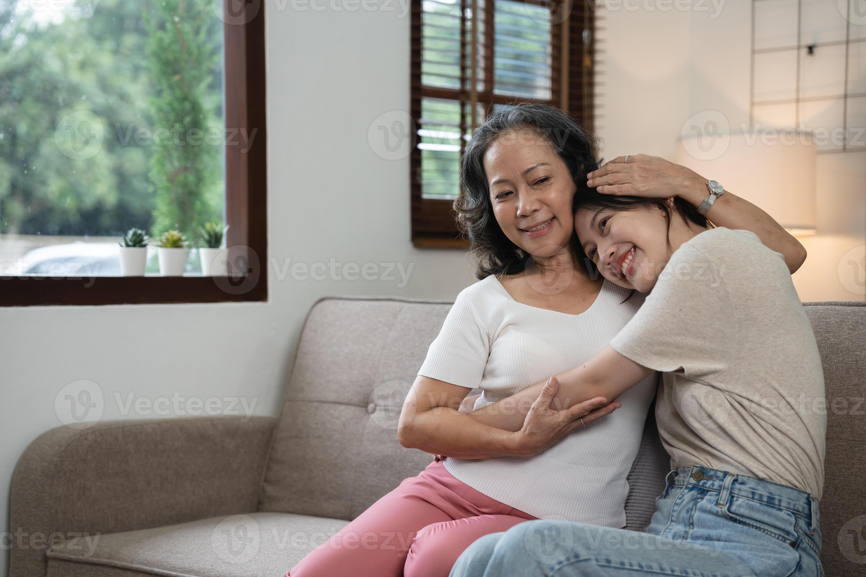 smiling grownup daughter hugging older mother. two generations concept, beautiful young woman ...