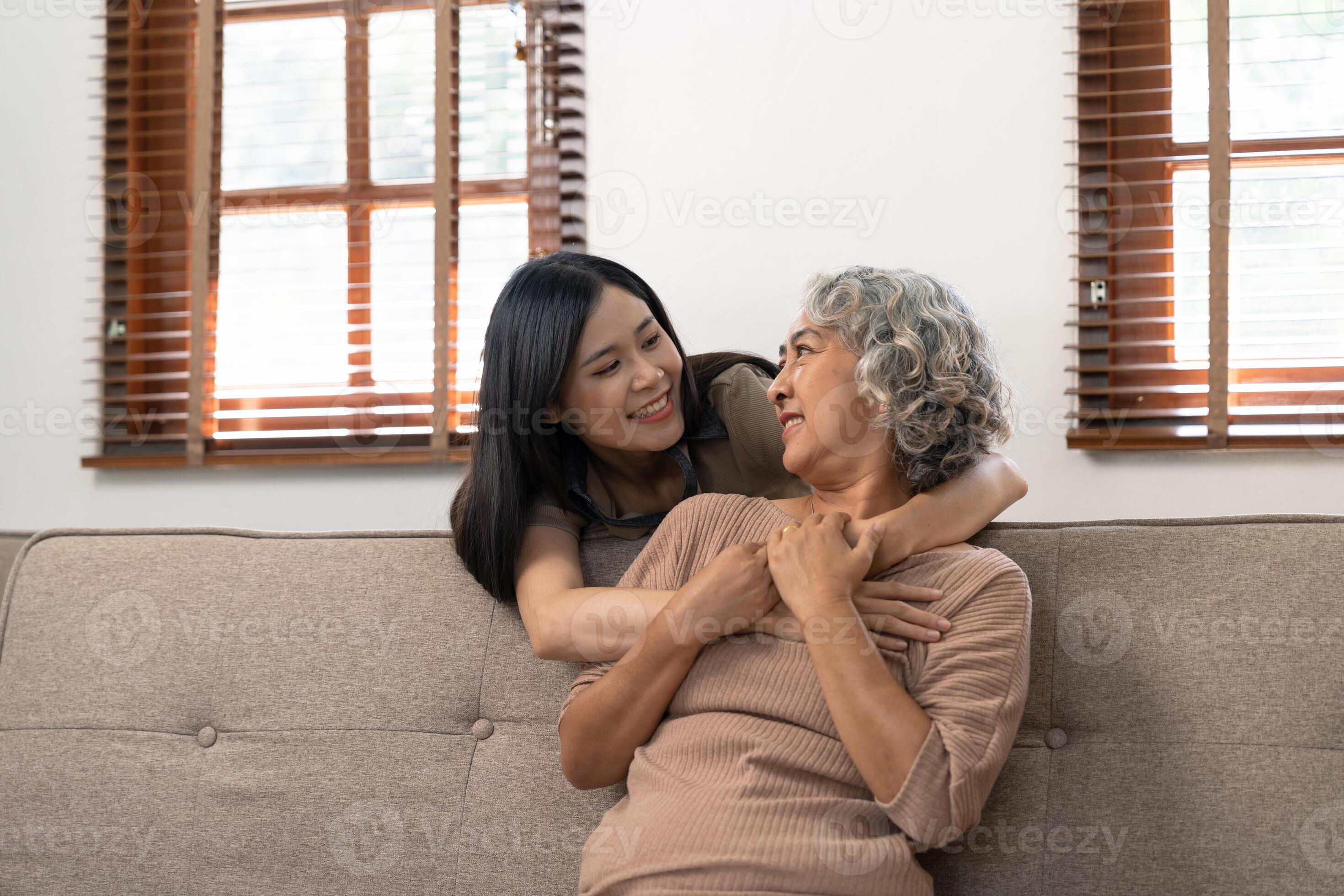 smiling grownup daughter hugging older mother. two generations concept, beautiful young woman ...