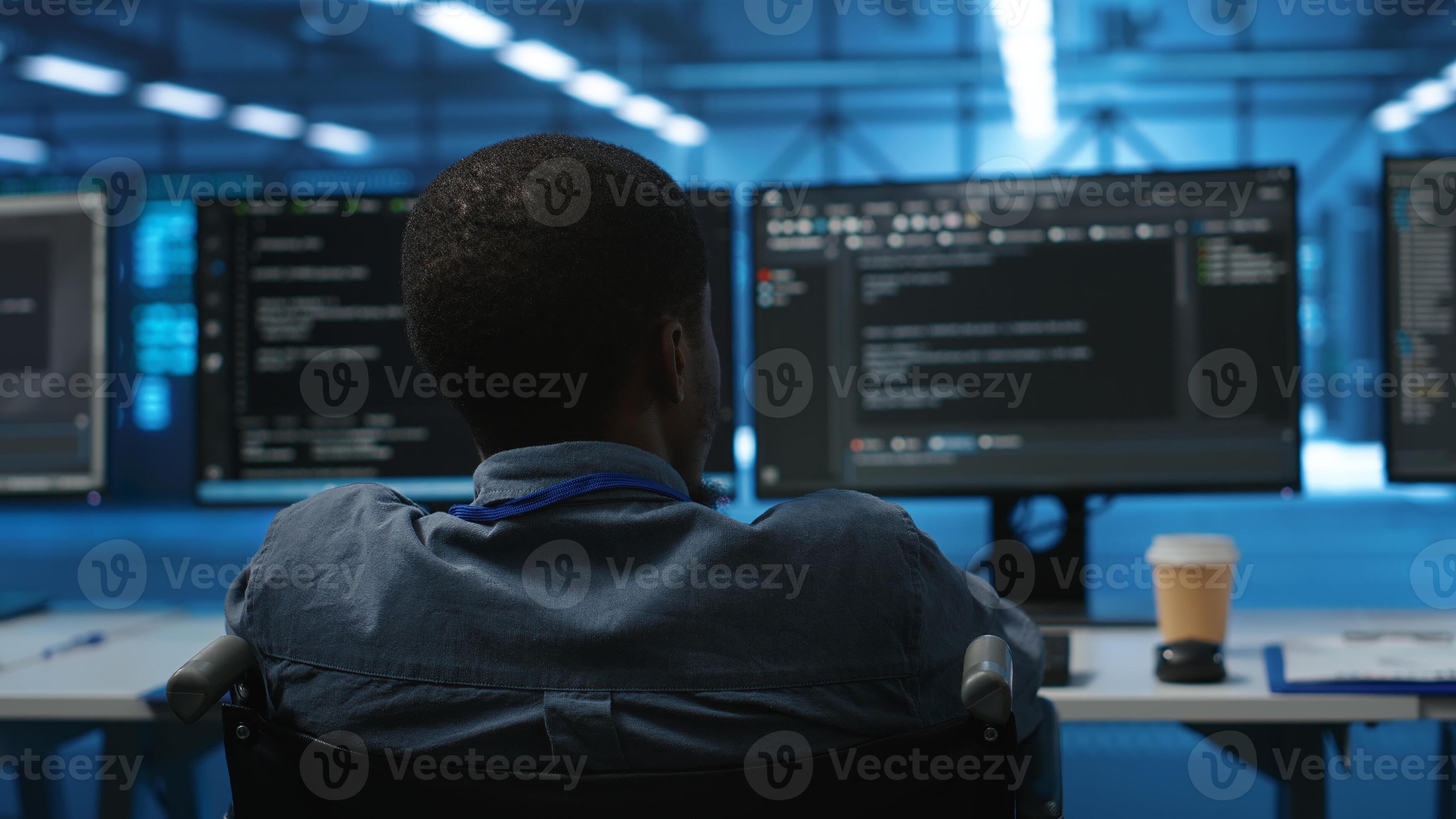 African american person with impairment in server farm ensuring data remains shielded from ...