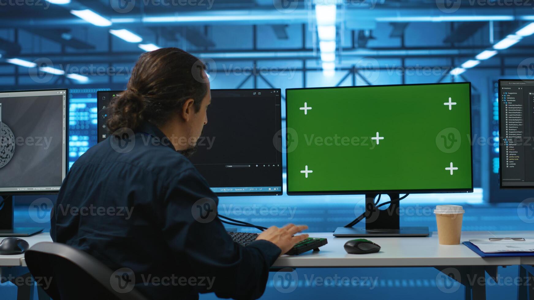 Engineer in server hub using green screen PC to repair equipment storing datasets. Professional ...