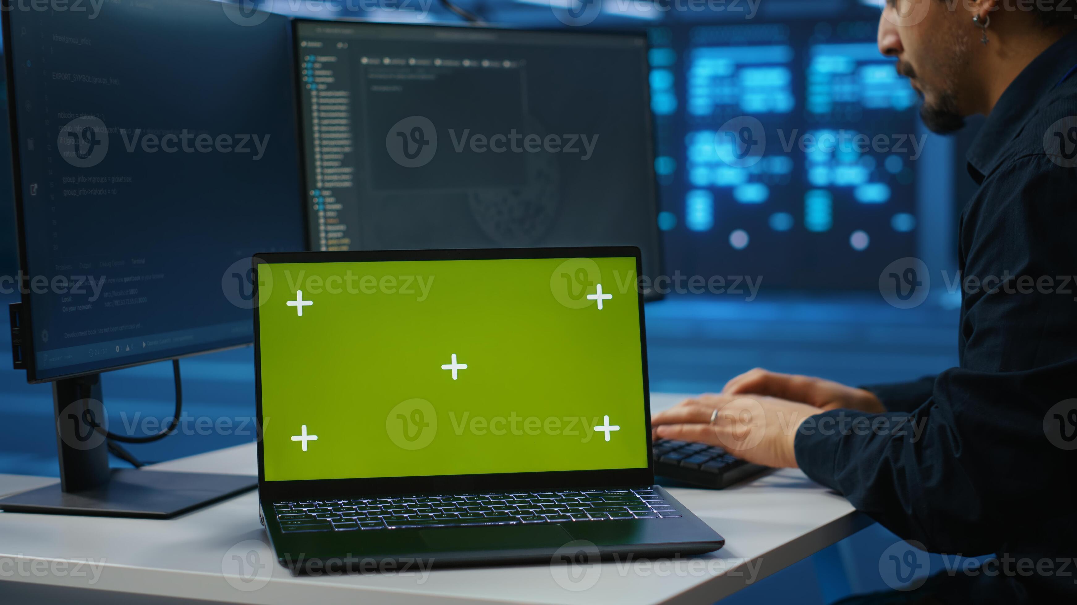 Isolated screen notebook in front of employee working in server farm ...