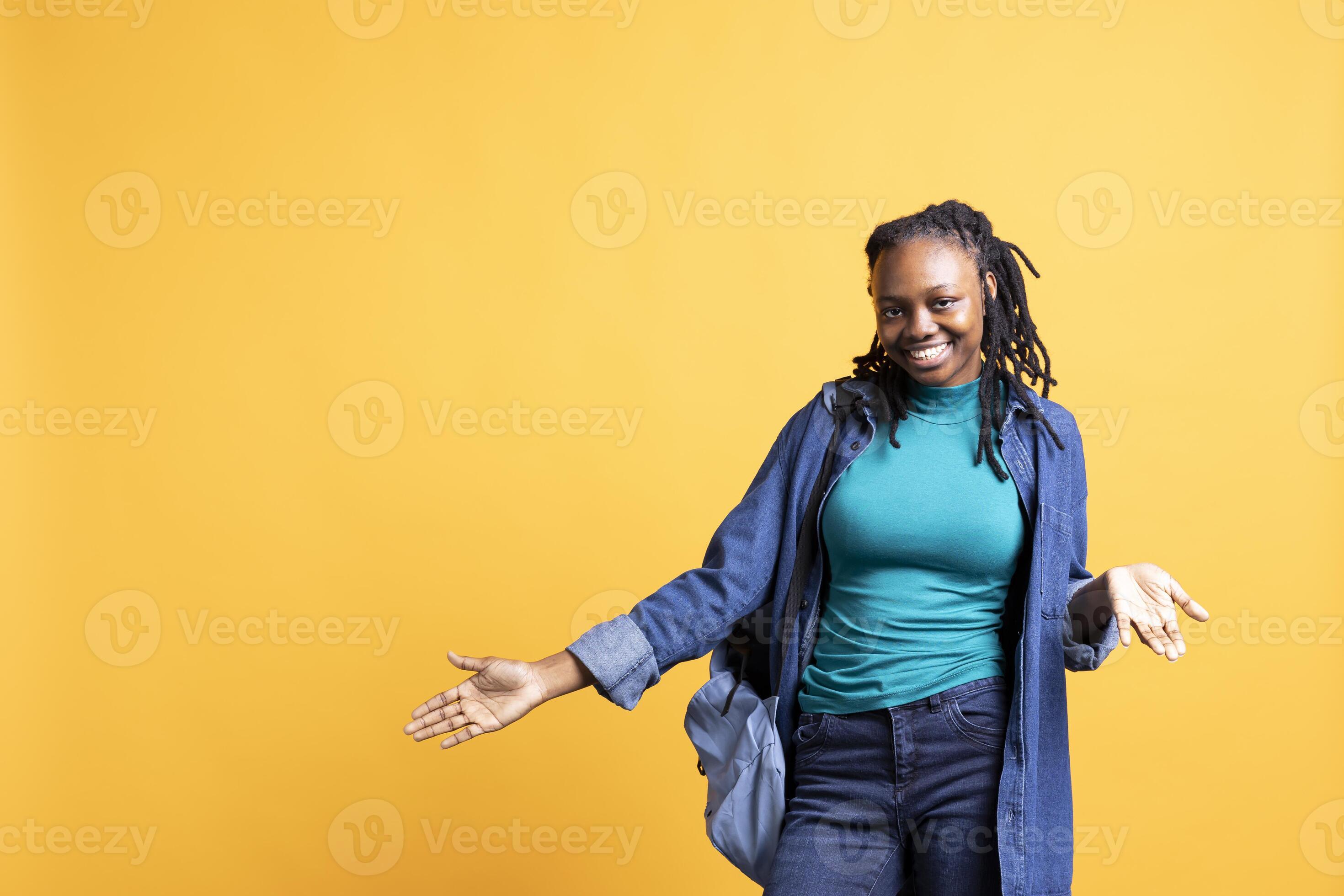 Happy young woman doing shrugging shoulders gesture, showing relaxed ...