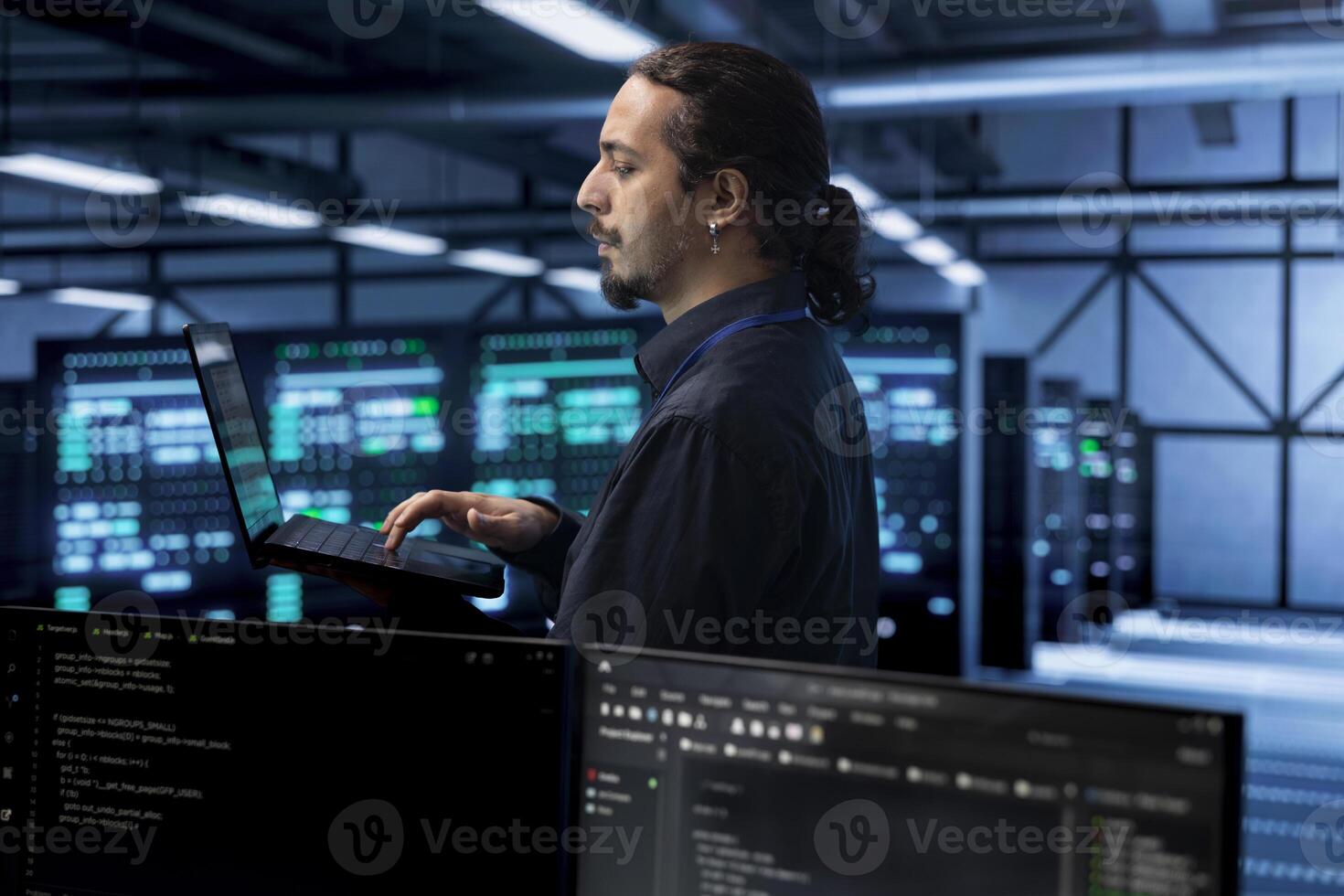 Engineer In Data Center Using Laptop To Find Firewall Misconfigurations