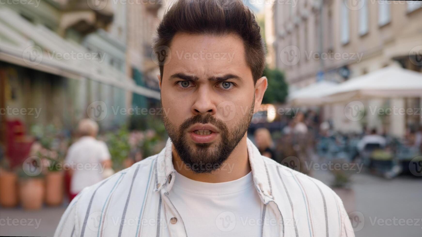 Close up angry Caucasian man frowning eyebrows city street outside ...