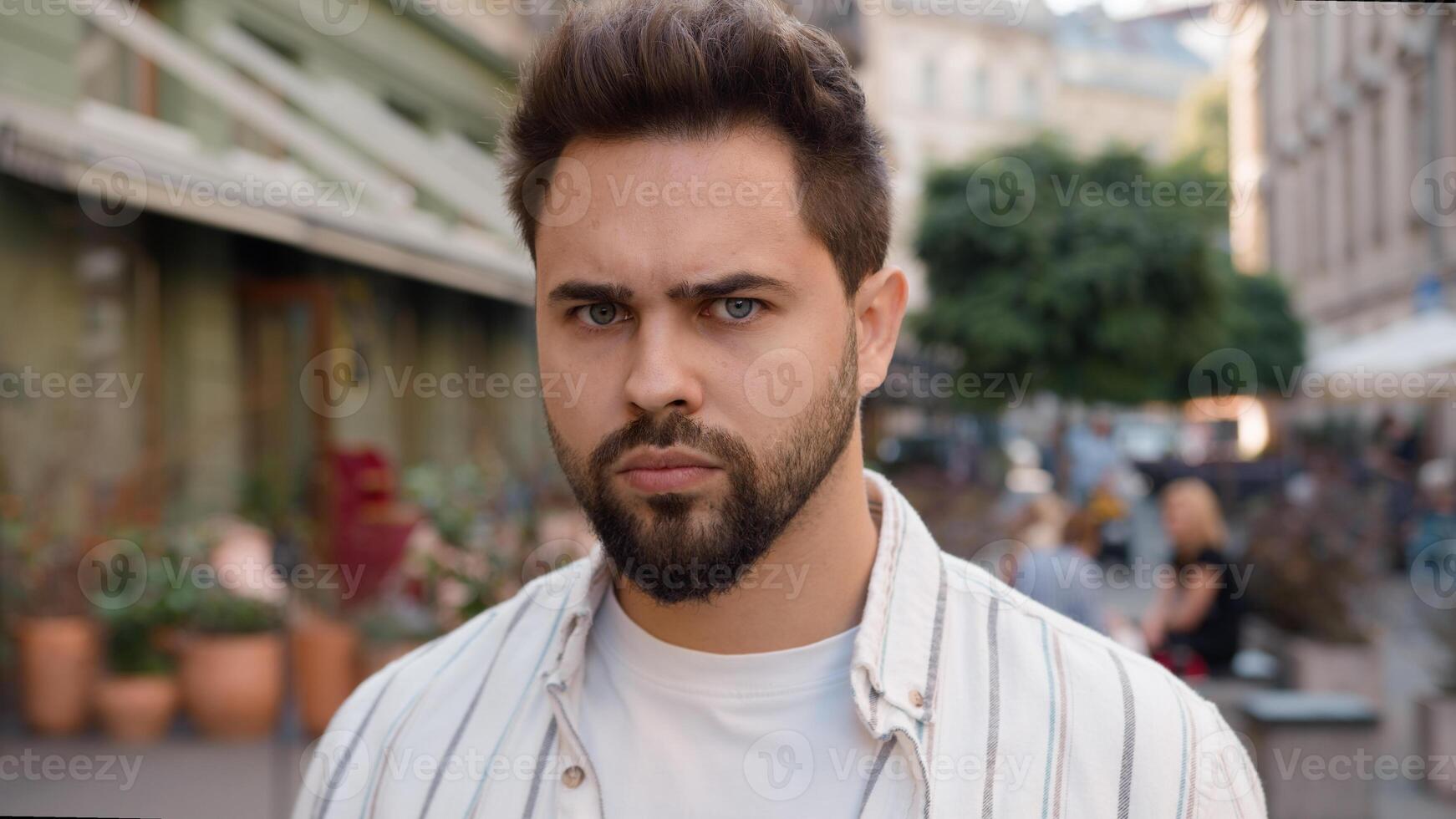 Close up angry Caucasian man frowning eyebrows city street outside ...