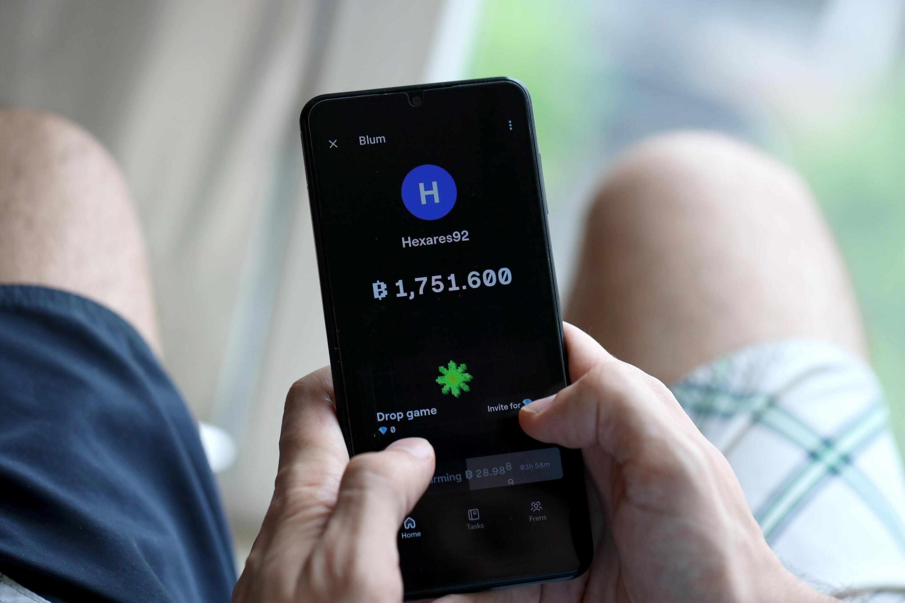 KYIV, UKRAINE - APRIL 20, 2024 Blum telegram bot on smartphone screen. Blum is a viral Telegram ...