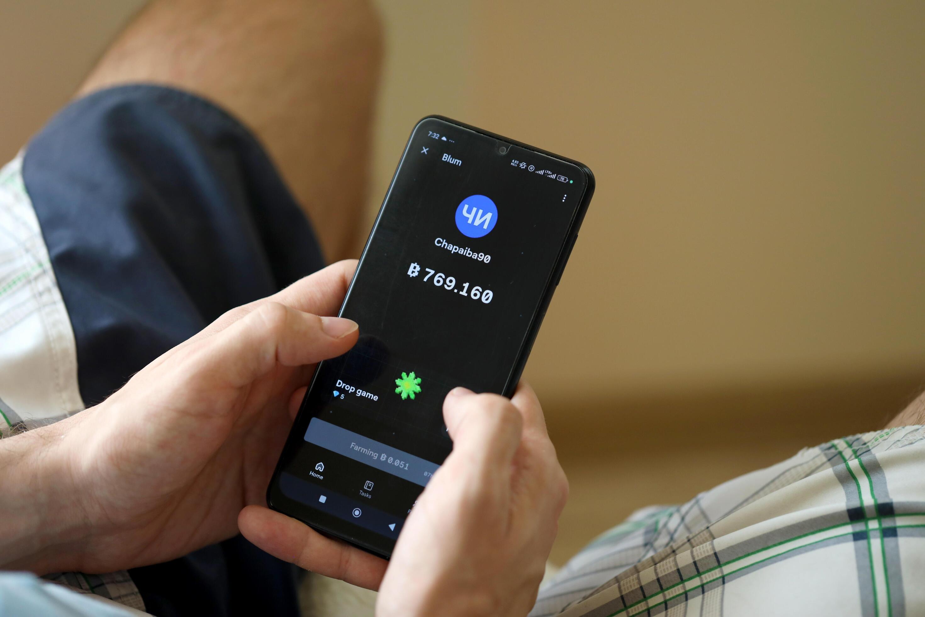 KYIV, UKRAINE - APRIL 20, 2024 Blum telegram bot on smartphone screen. Blum is a viral Telegram ...