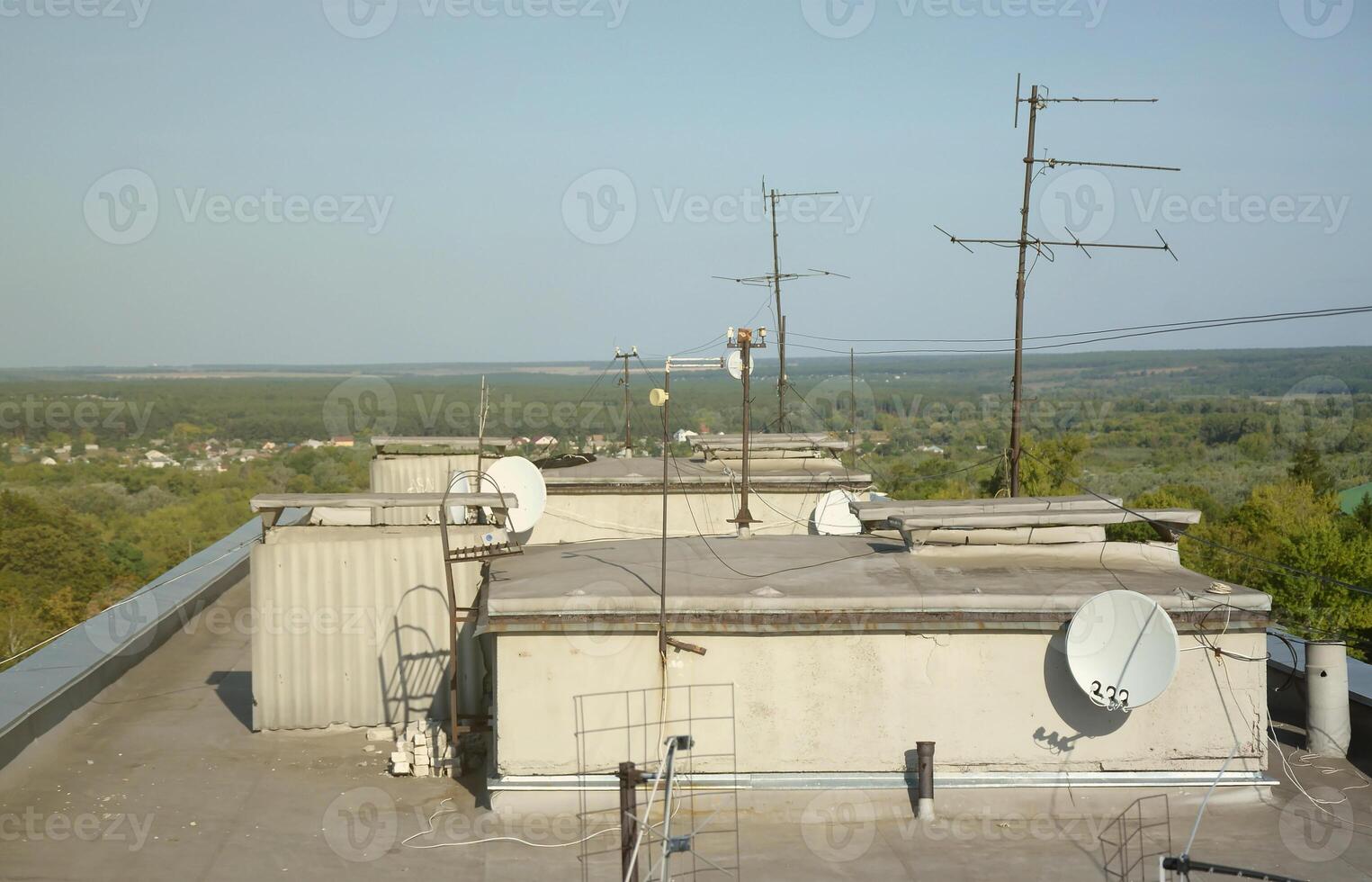 White satellite dish with three converters mounted on residental ...