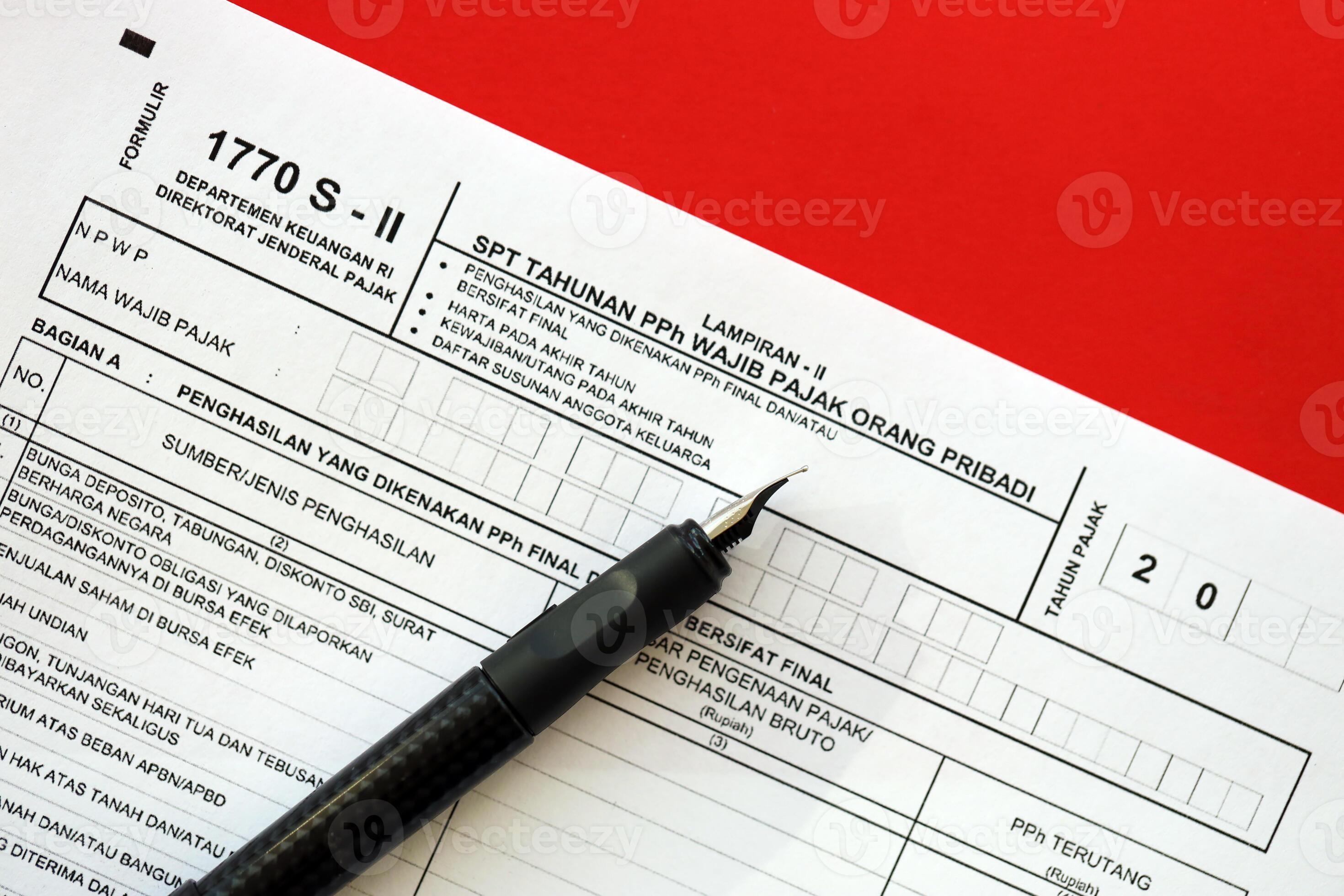 Indonesian tax form 1770 S - 2 Individual Income Tax Return and pen on table 46600570 Stock ...