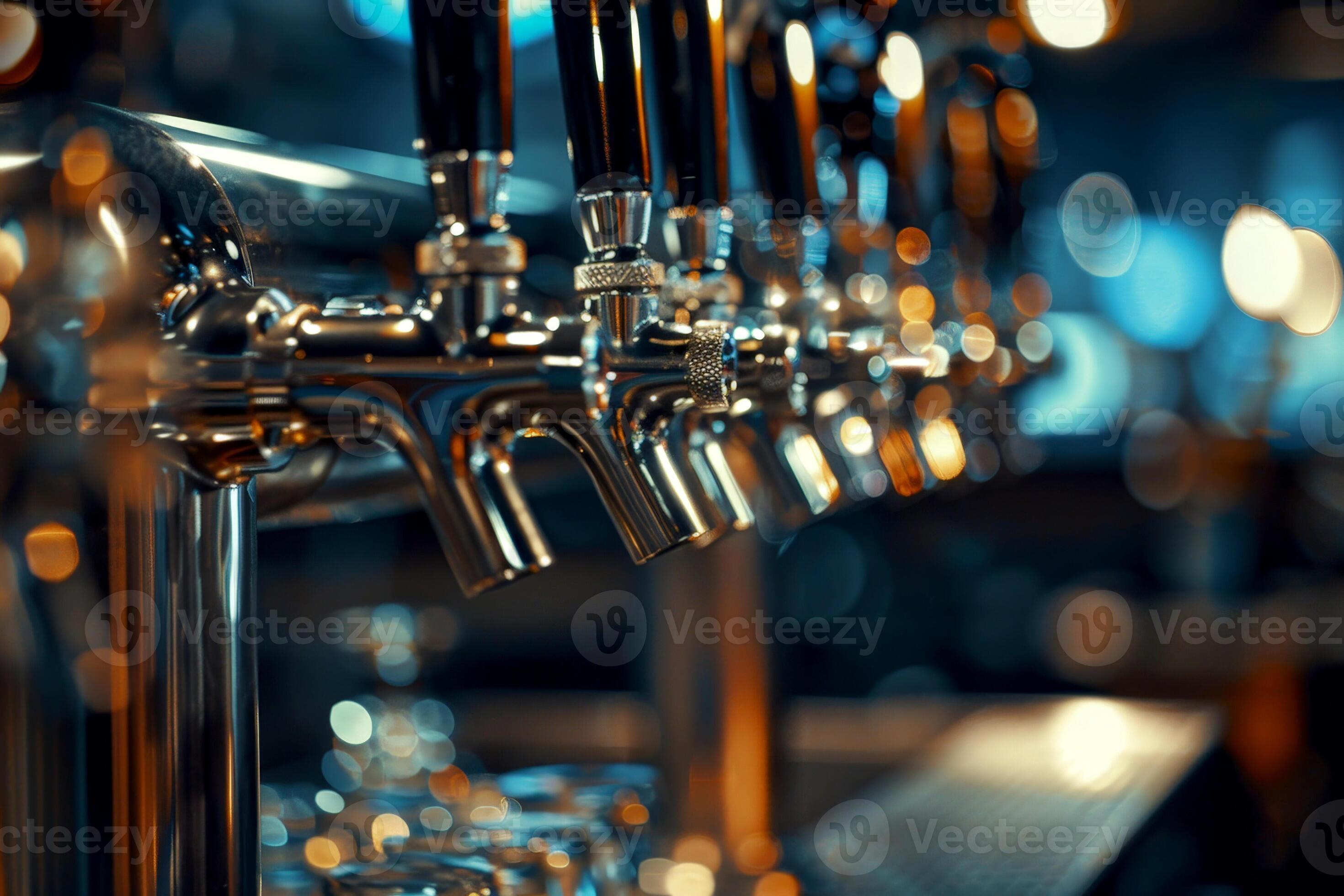 Closeup of beer tap handles lines in a bar against a dark background ...