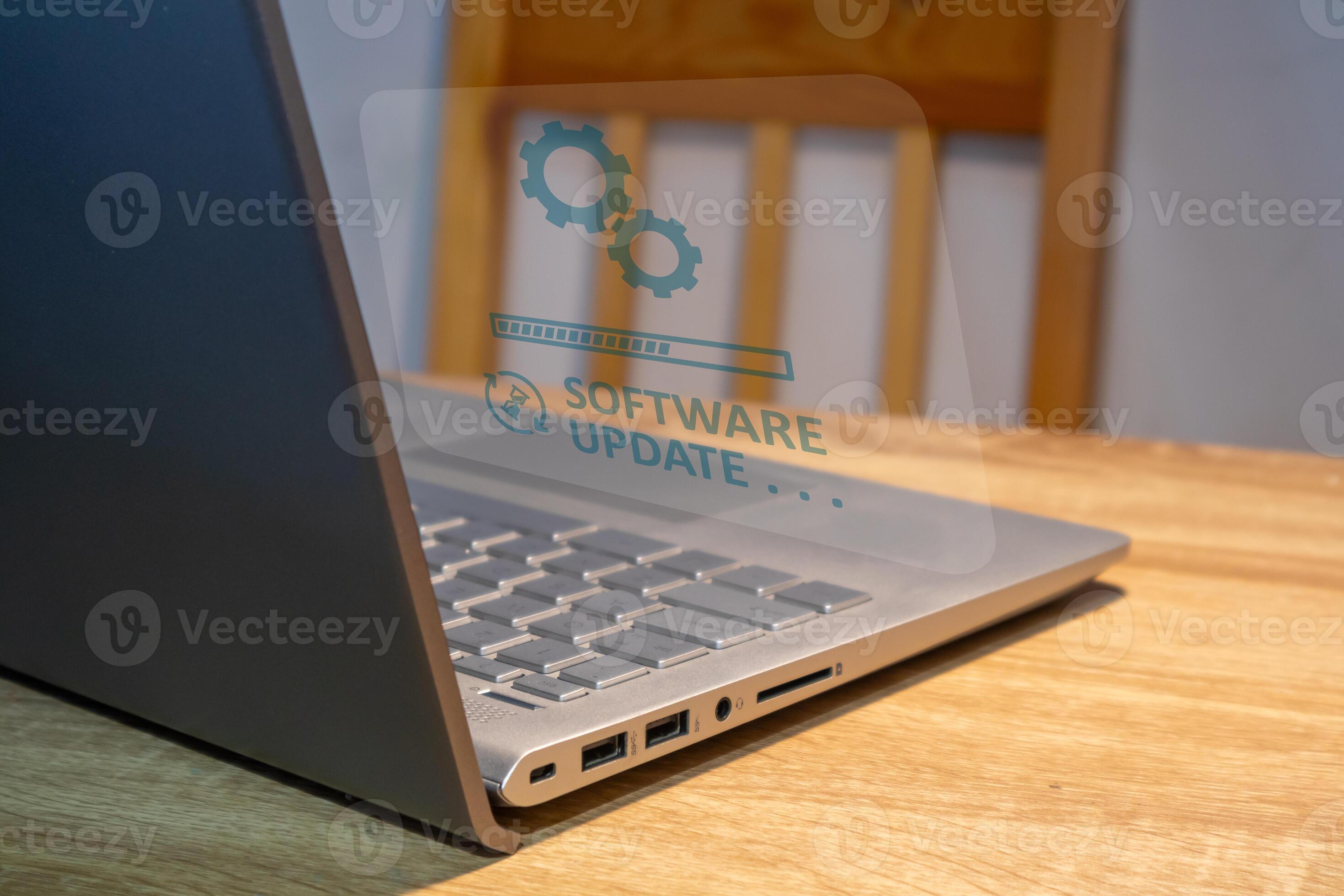 Software System Update Process Concept A Laptop On The Table With Updating Progress Bar On
