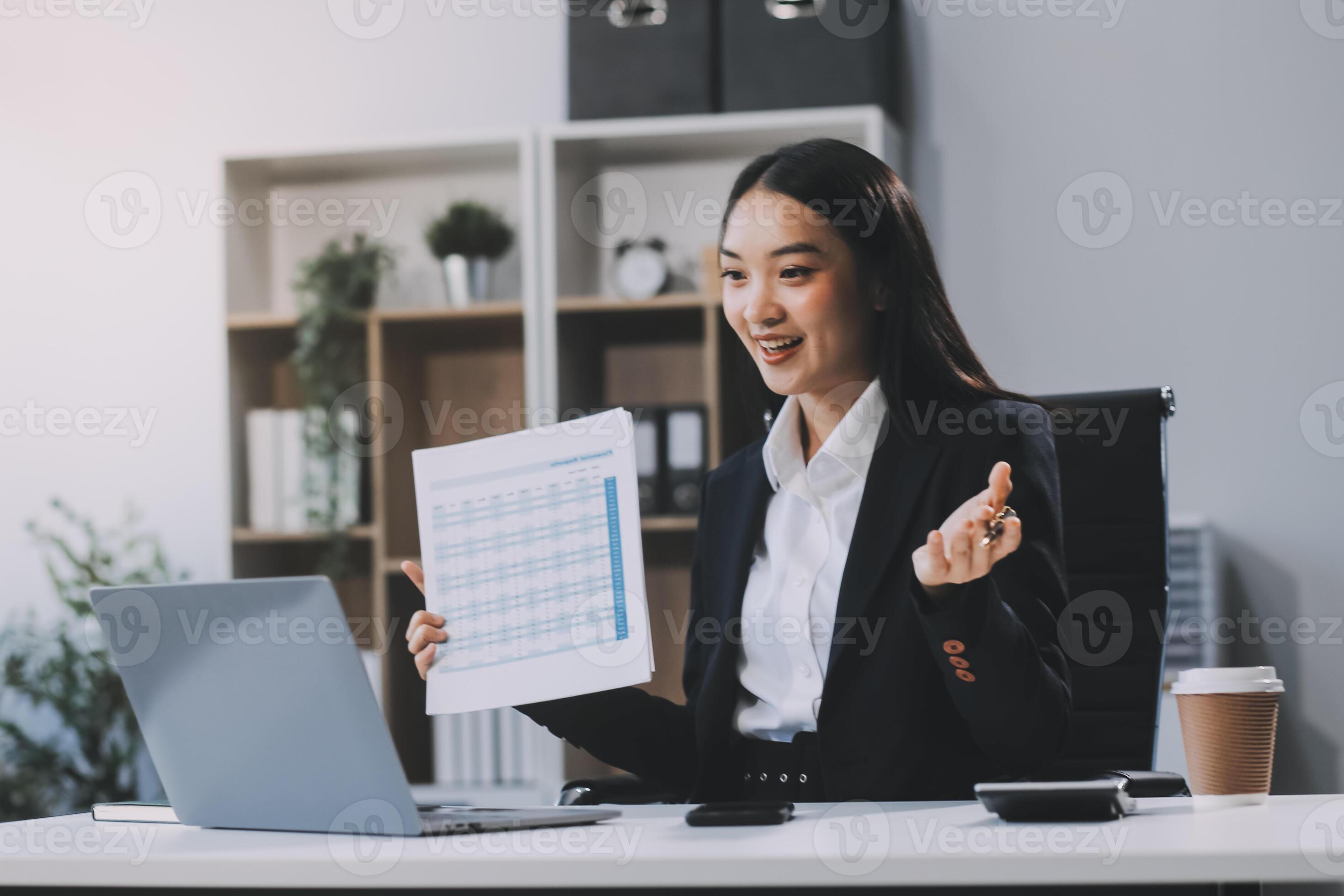 feliz joven empresaria asiática trabajando en una laptop y tomando notas en la oficina. 46672635 ...