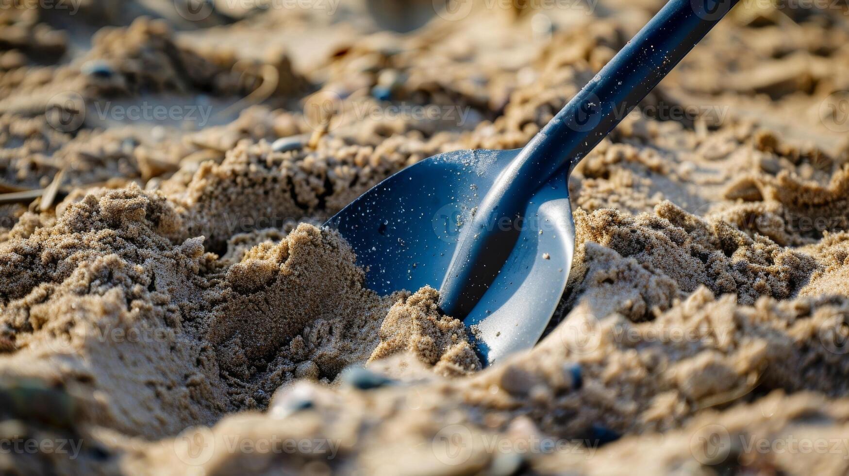 A compact shovel for digging up buried items and removing sand from ...