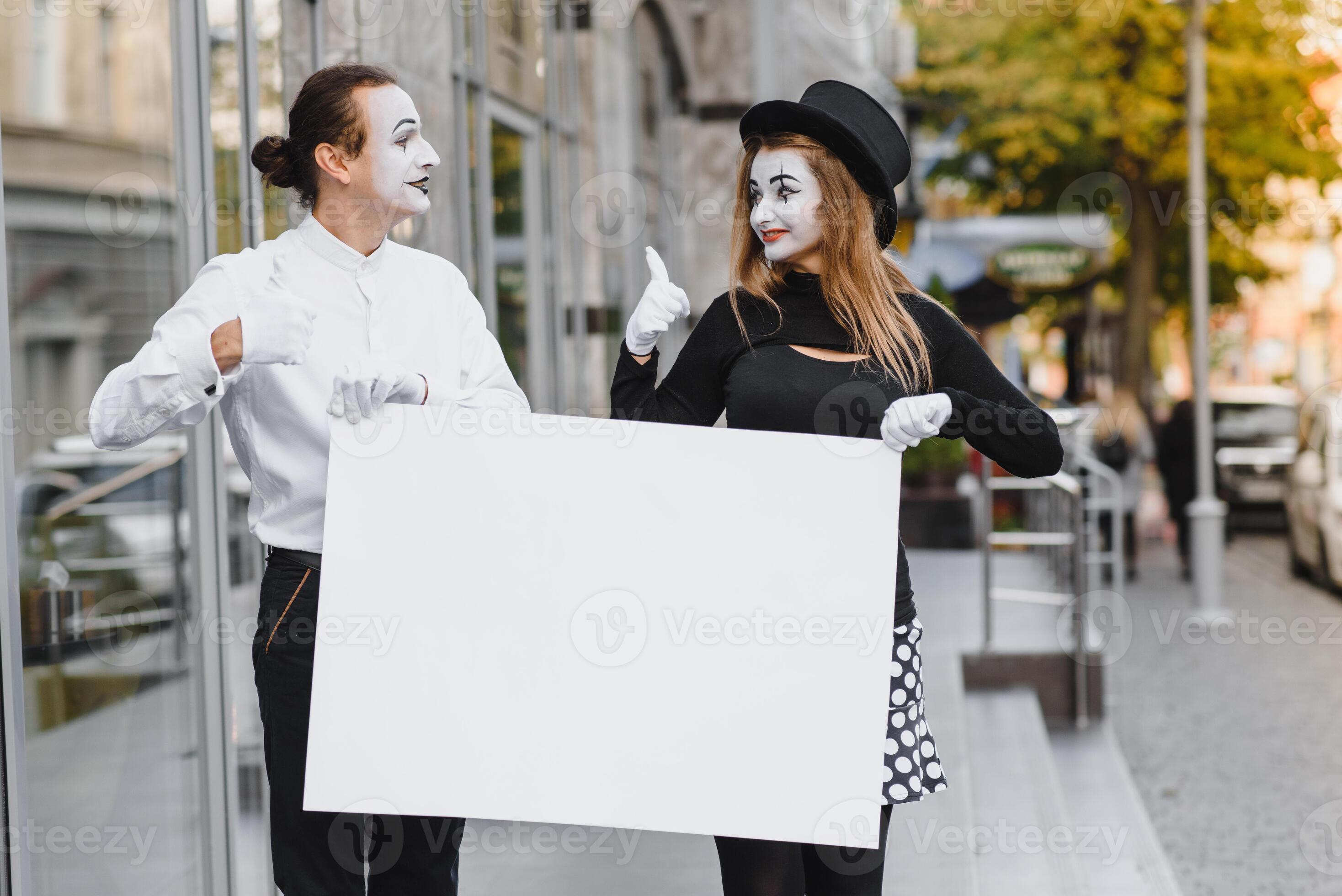 couple funny mimes holding sign 46750808 Stock Photo at Vecteezy