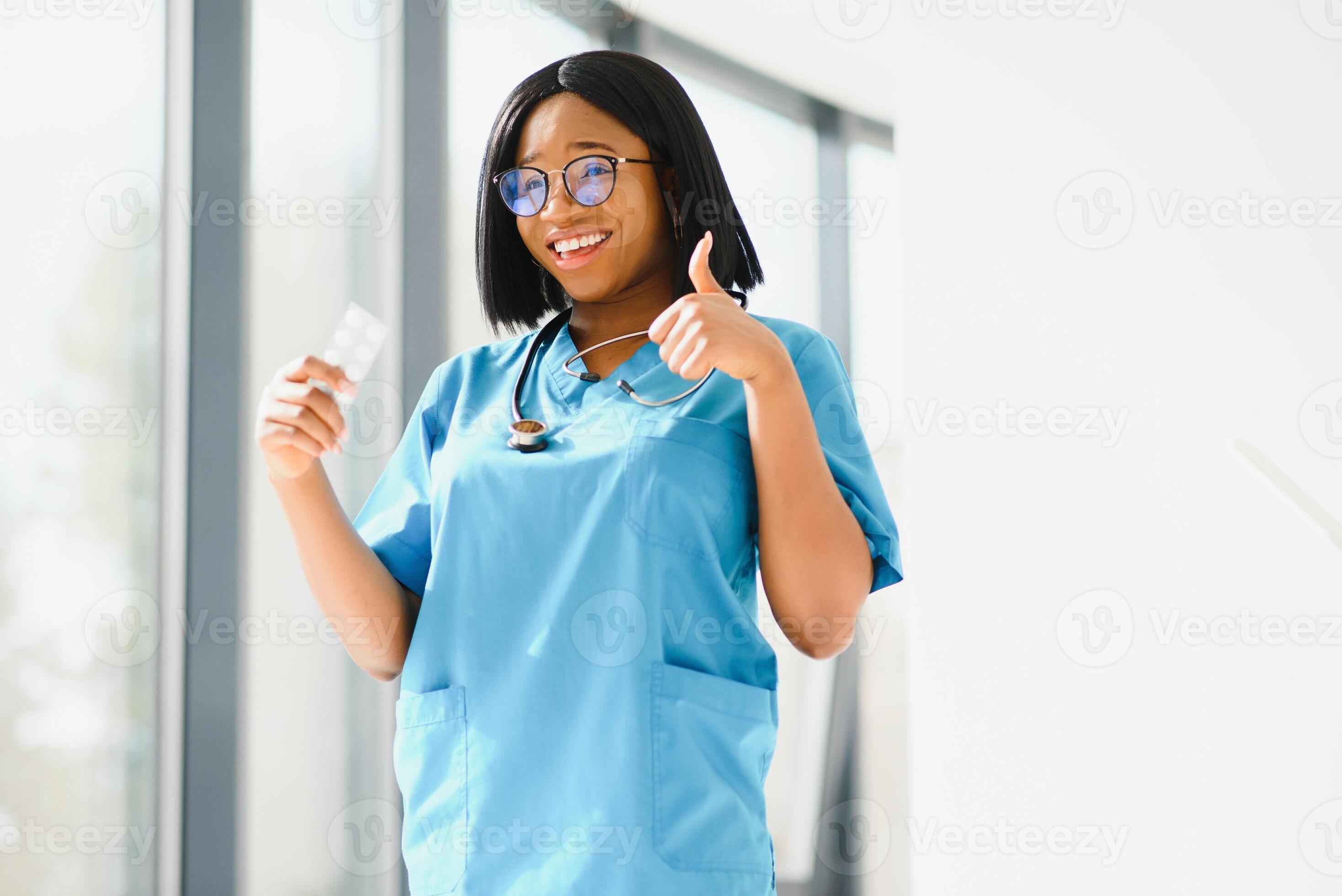 smiling african american nurse with stethoscope holding pill. 46752912 ... smiling african american nurse with stethoscope holding pill. 46752912 ...