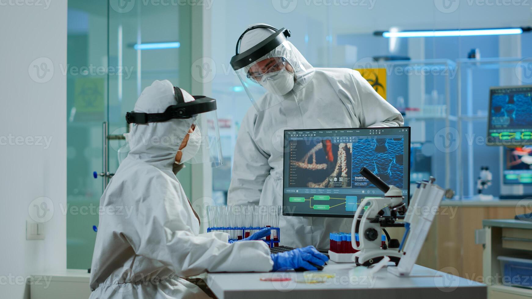 Scientist Team In Prorection Suit Arguing In Front Of Pc Looking At
