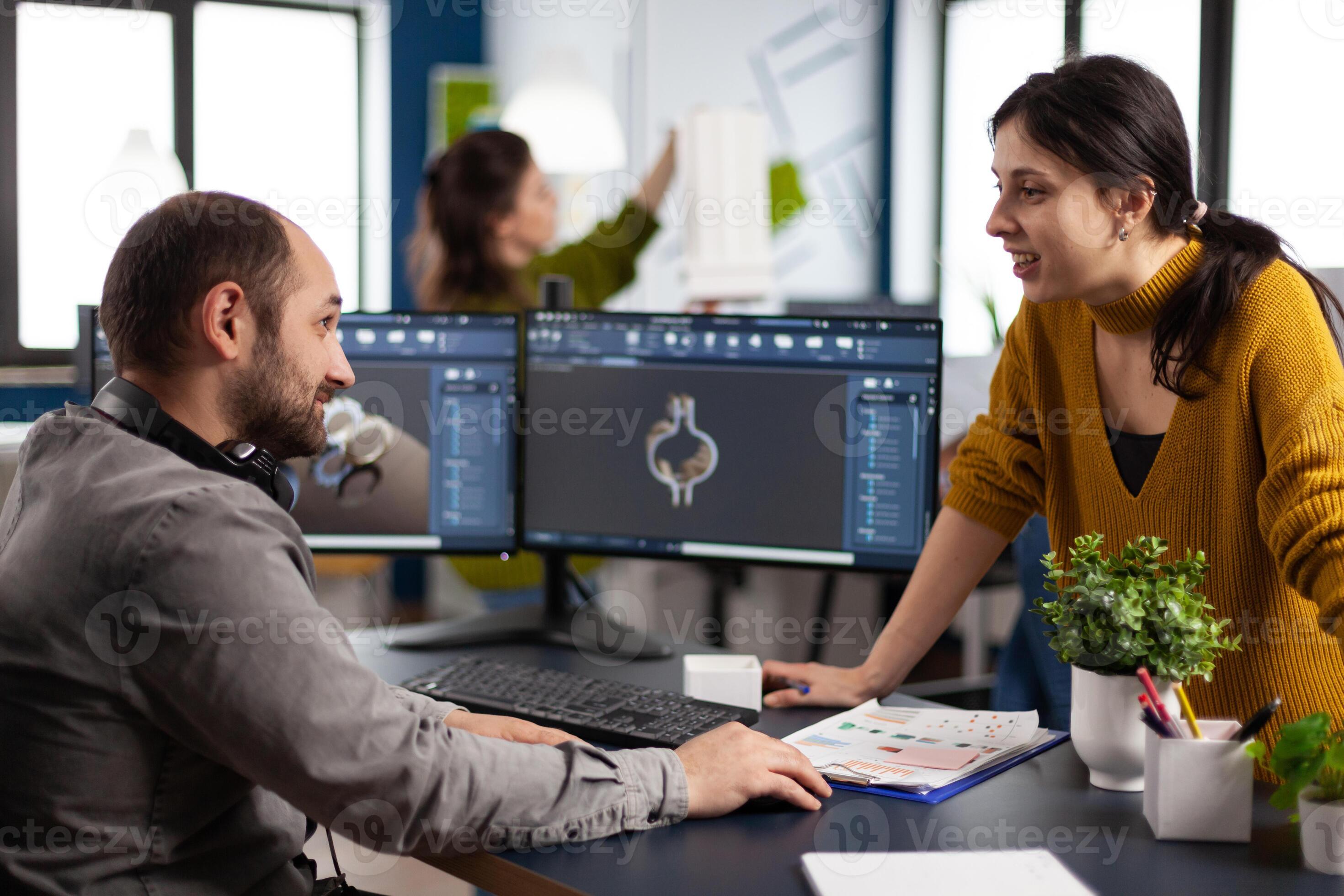 Coworkers engineer working on modern cad program developing industrial metallic construction ...