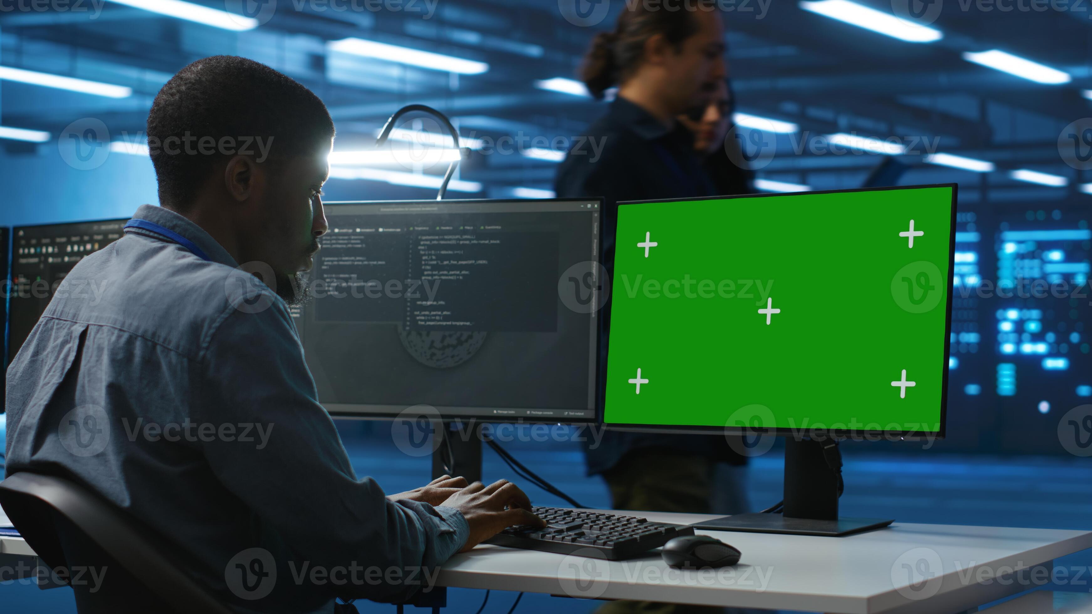 Programmer Coding On Isolated Screen Computer In Data Center Supervising Server Rows In