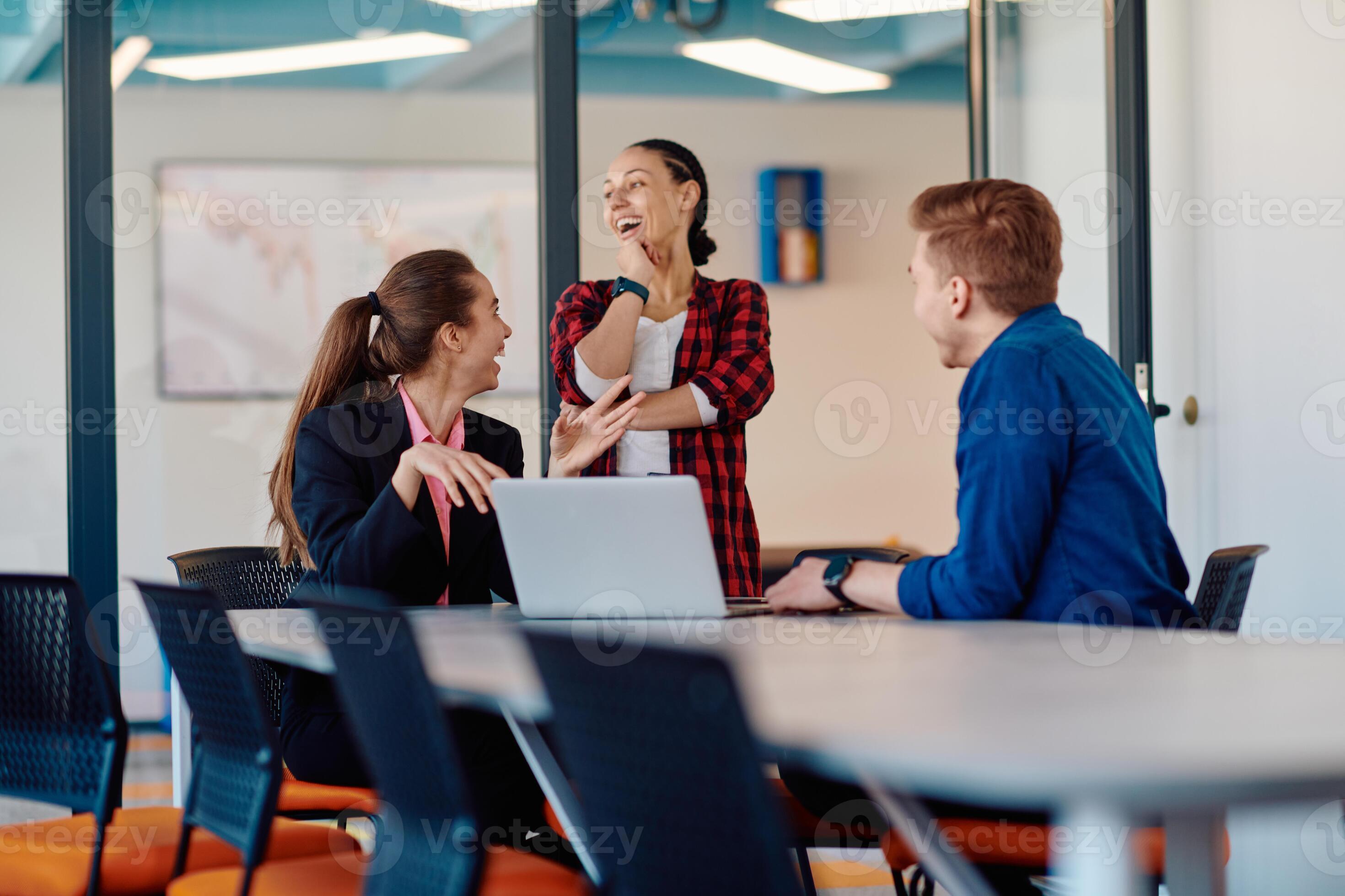 A team of successful programmers sits in a startup office, strategizing new business projects ...