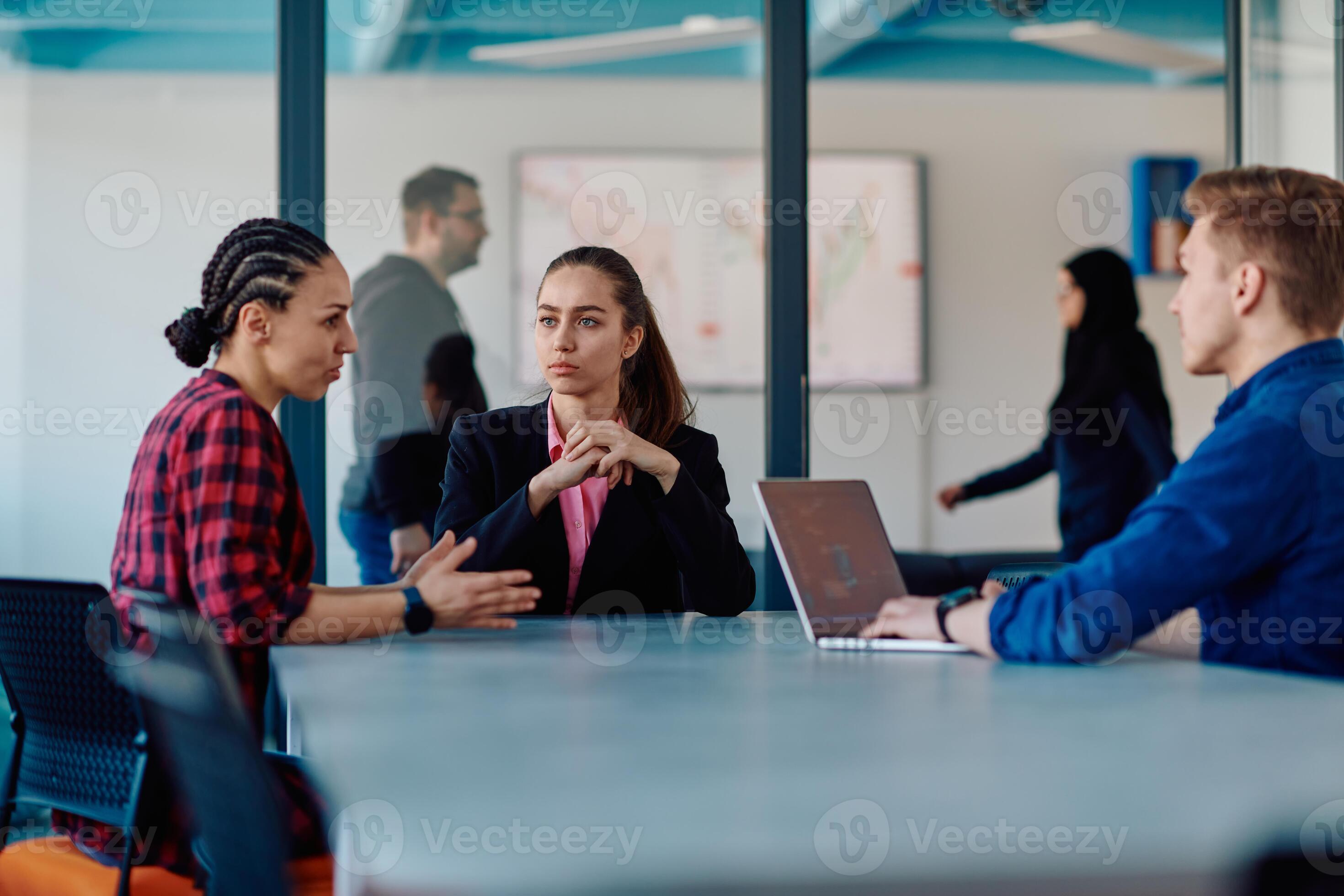 A team of successful programmers sits in a startup office, strategizing new business projects ...